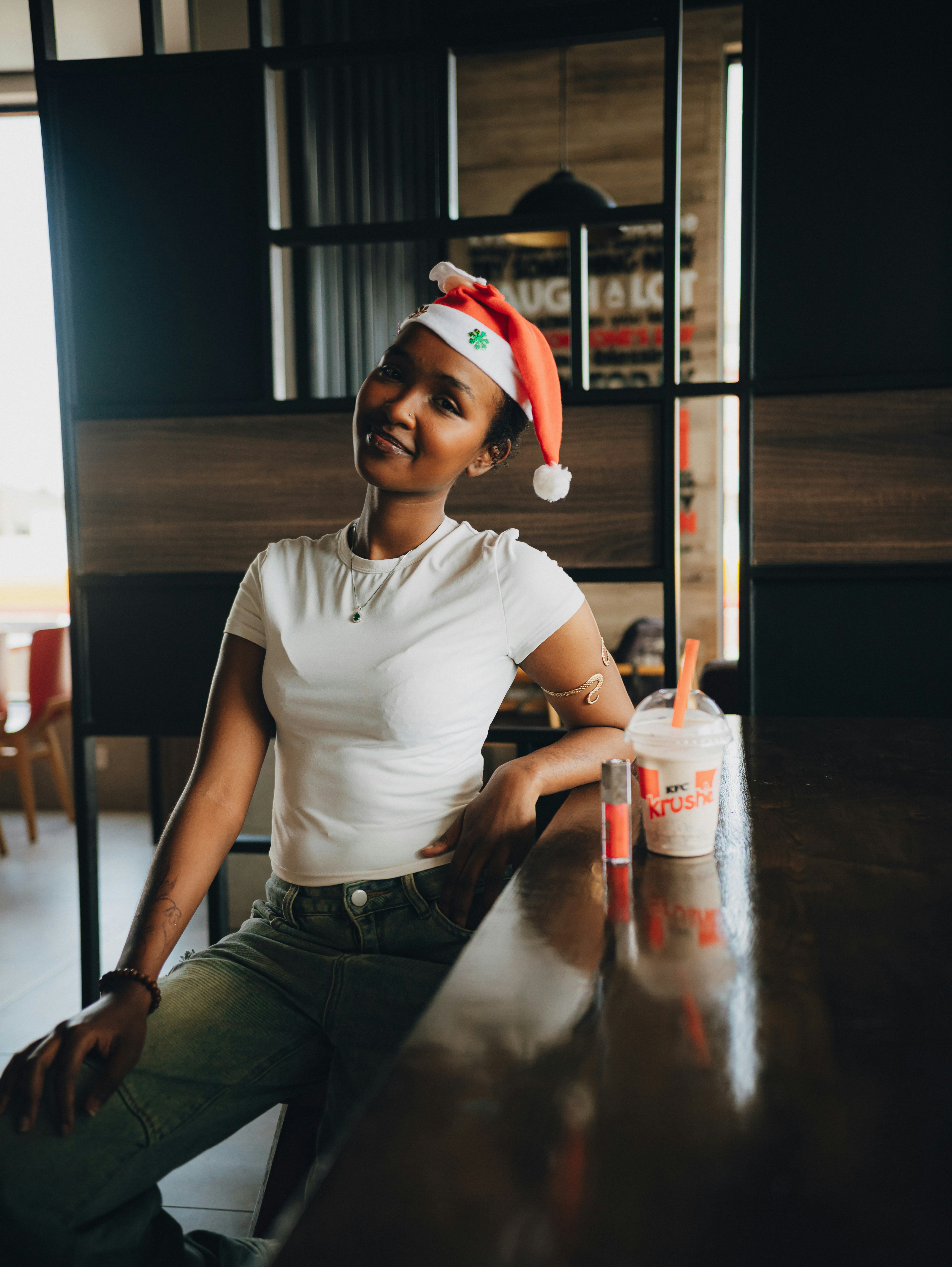 Santa hat, cafe glow: a candid smile at the counter