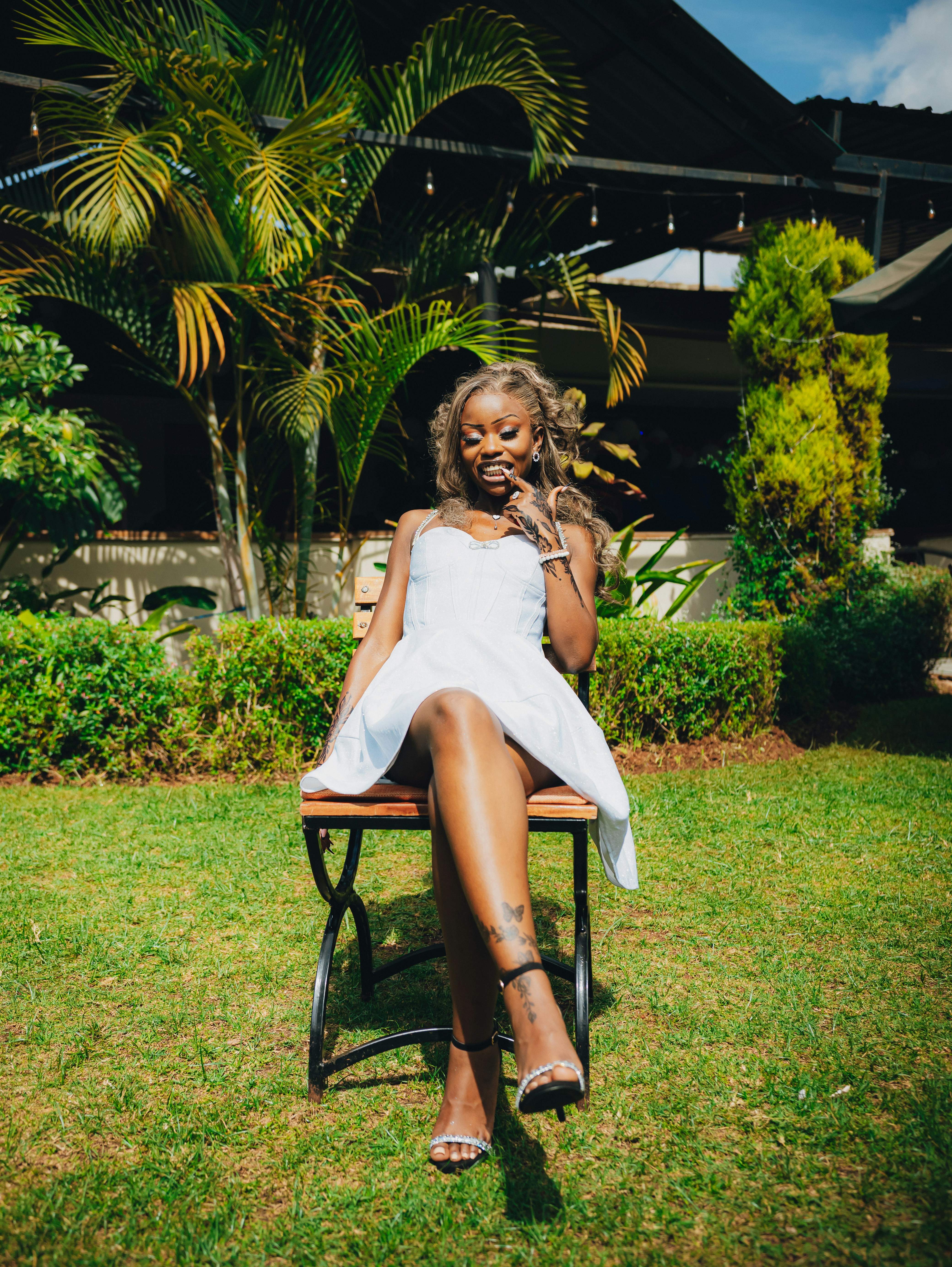 Sunlit Confidence: A Lady in White Graces a Garden Stage