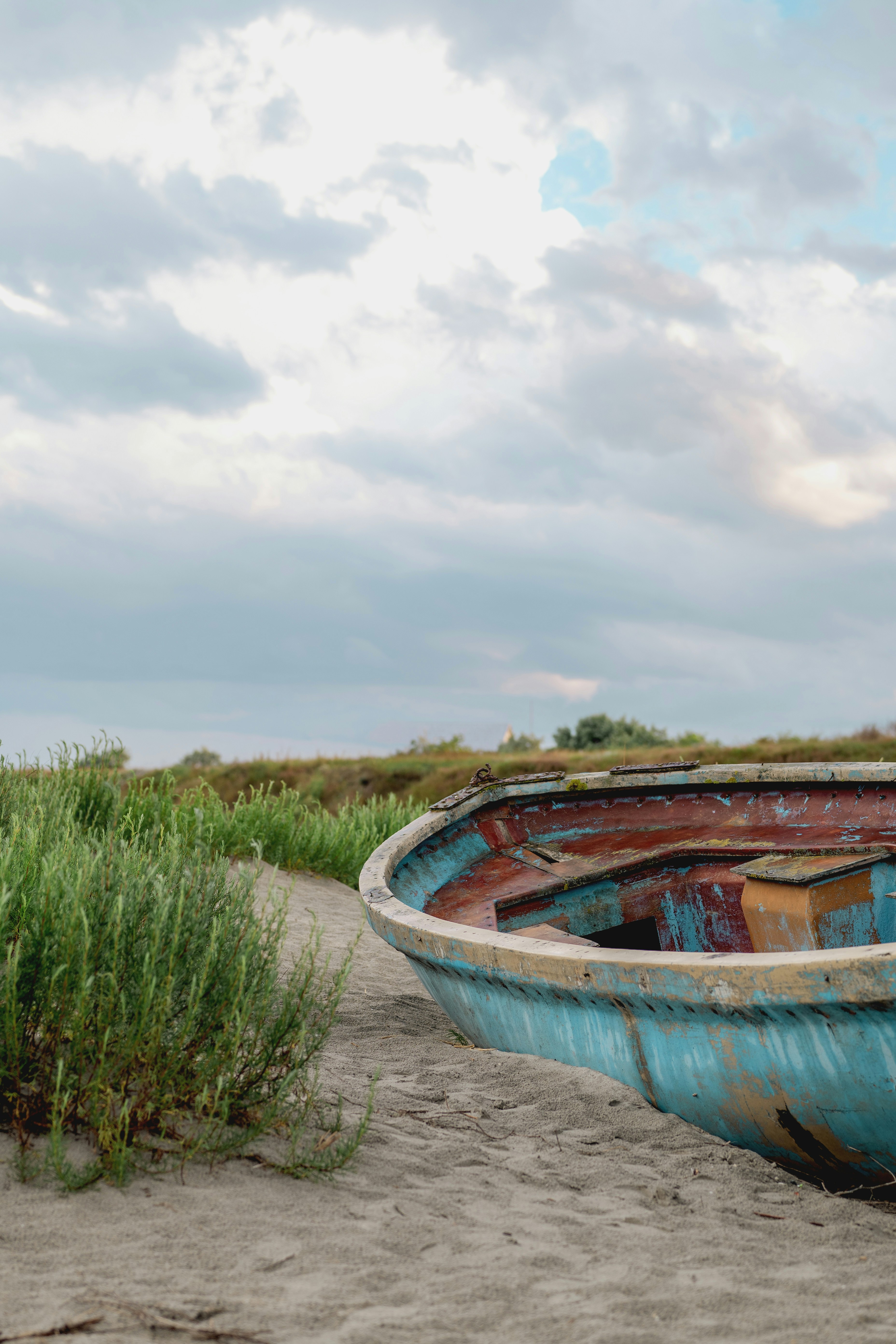 Weathered Boat on a Quiet Shore: Colors of Rust and Sand