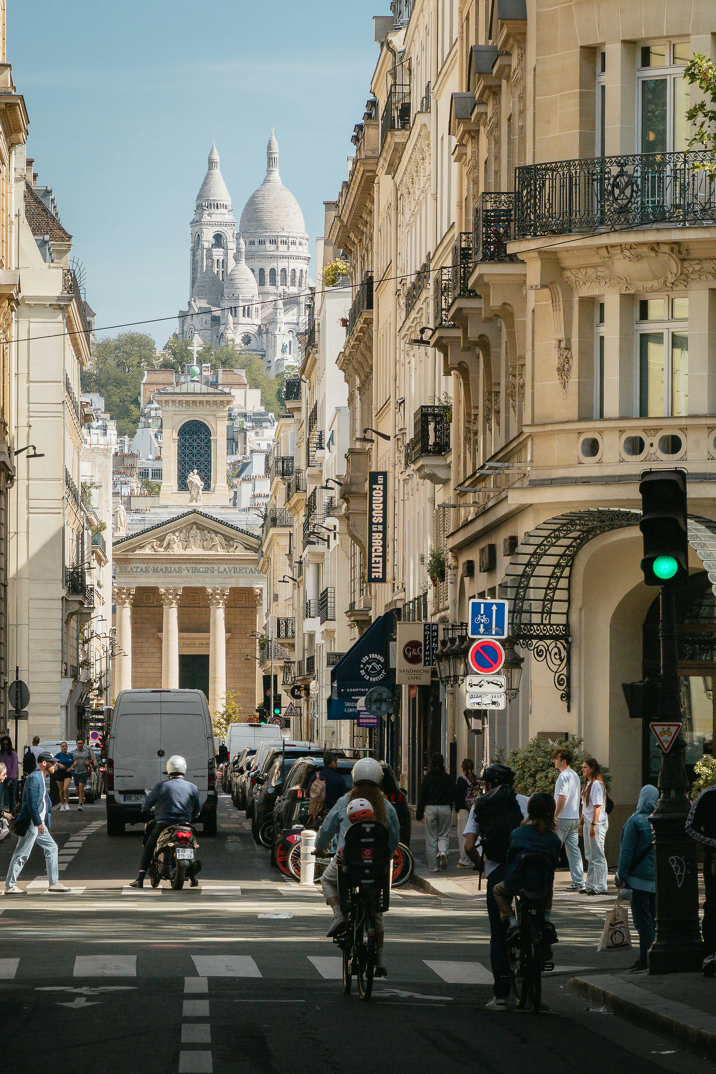 Montmartre's Ascent: Street Life Framing Sacre-Coeur in the Distance