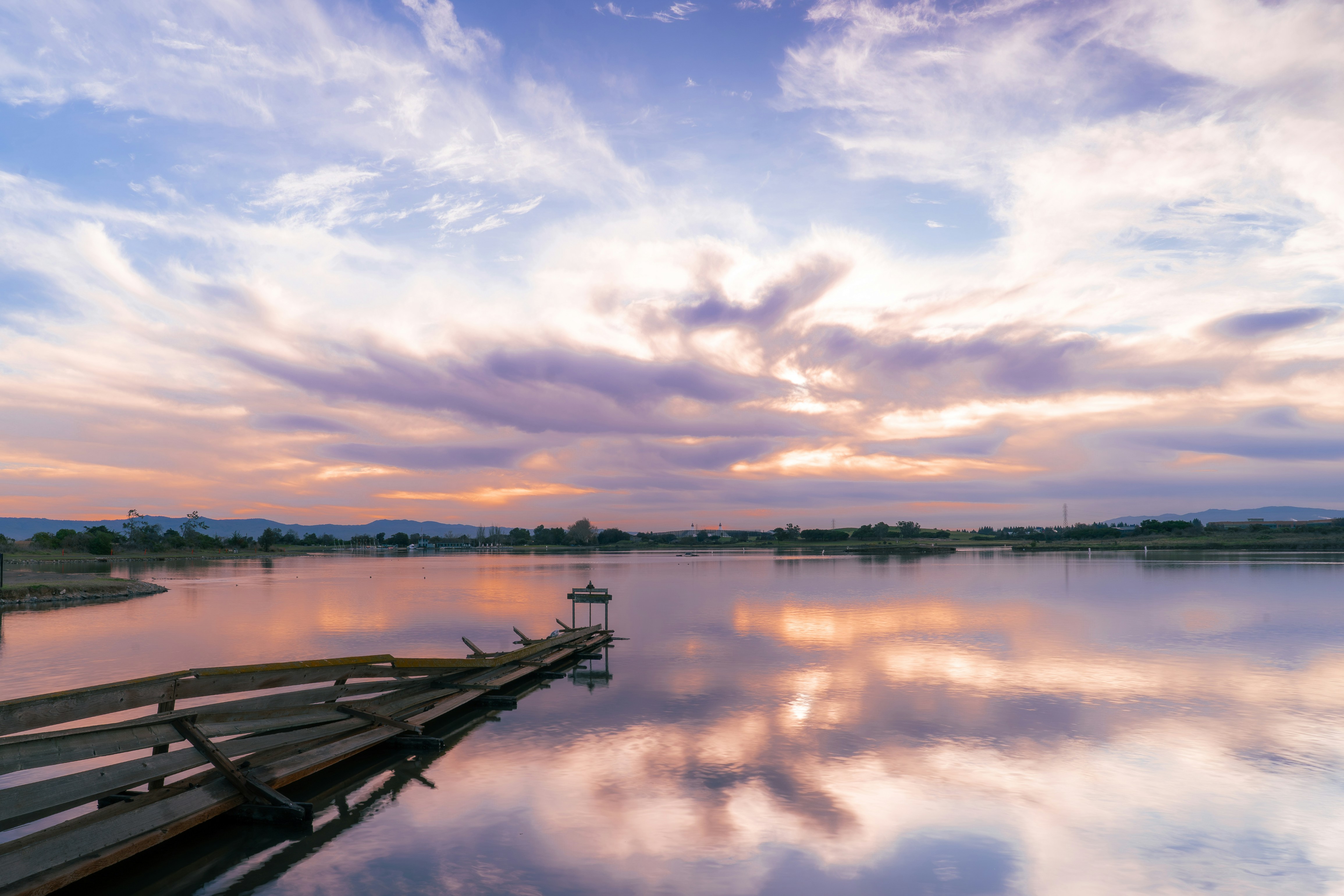 Dawn on Glassy Waters: A Quiet Pier Reaches toward the Horizon