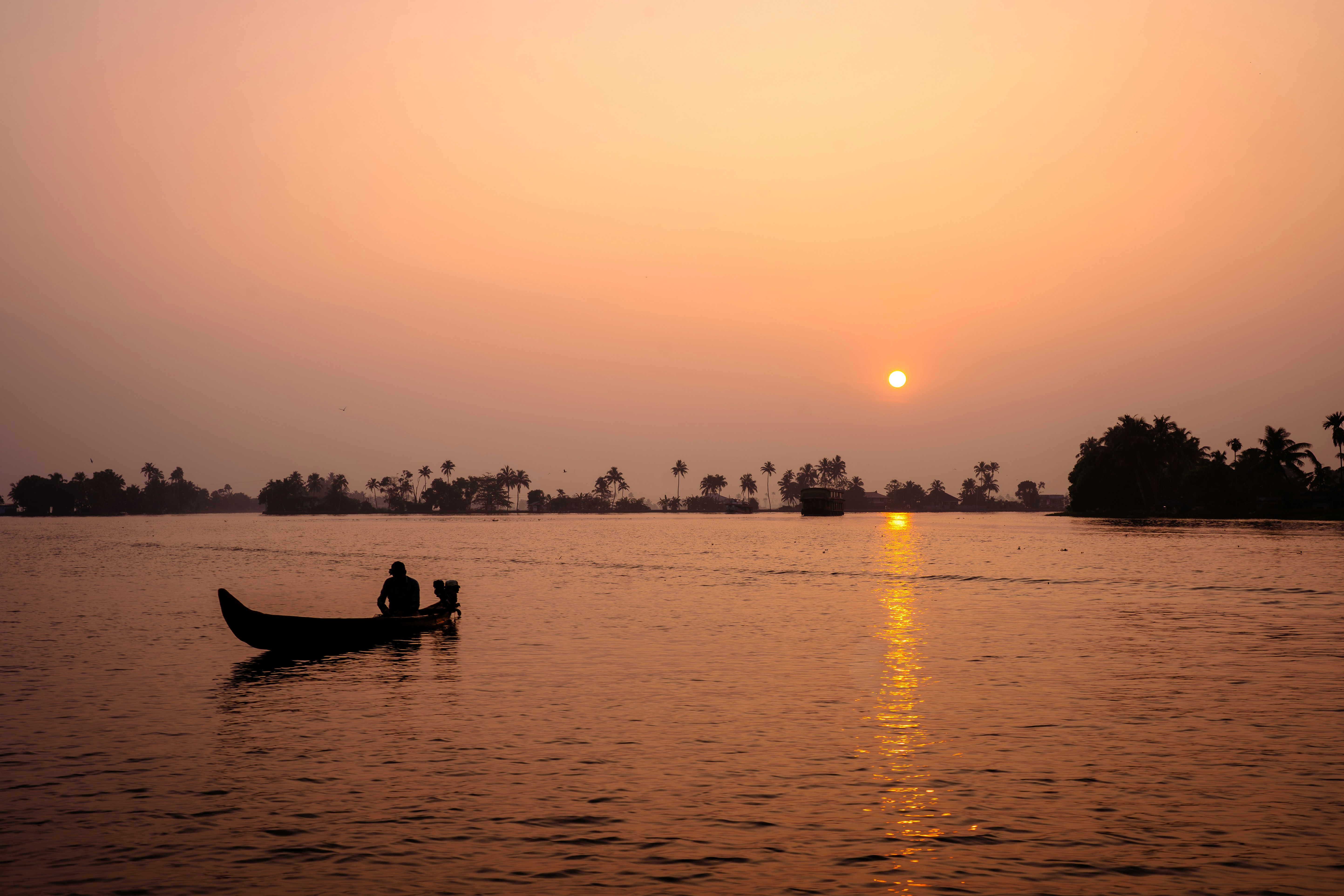 Sunset Reach: A Silhouette Row Across Quiet Waters