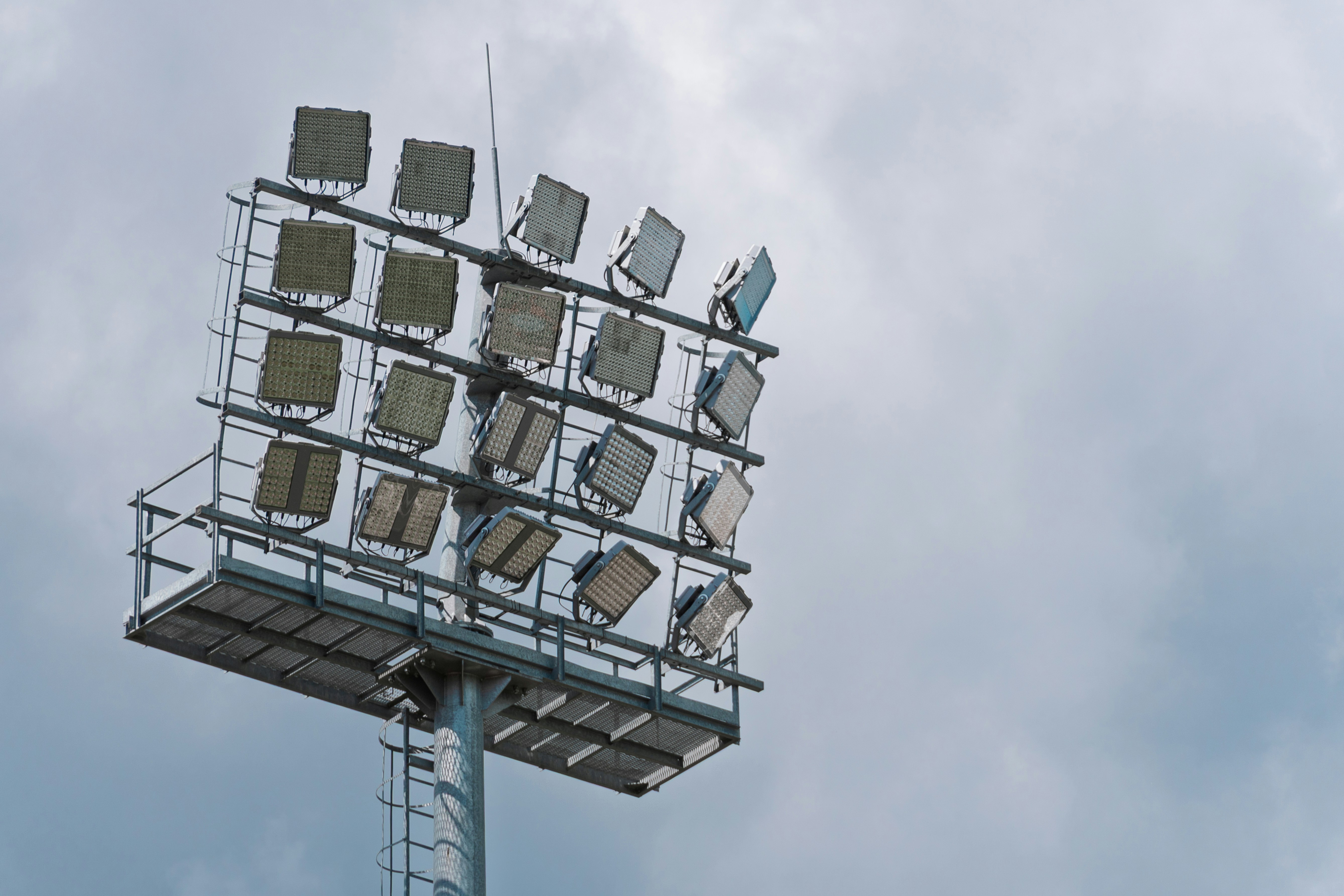 Towering Floodlights under Teal Sky