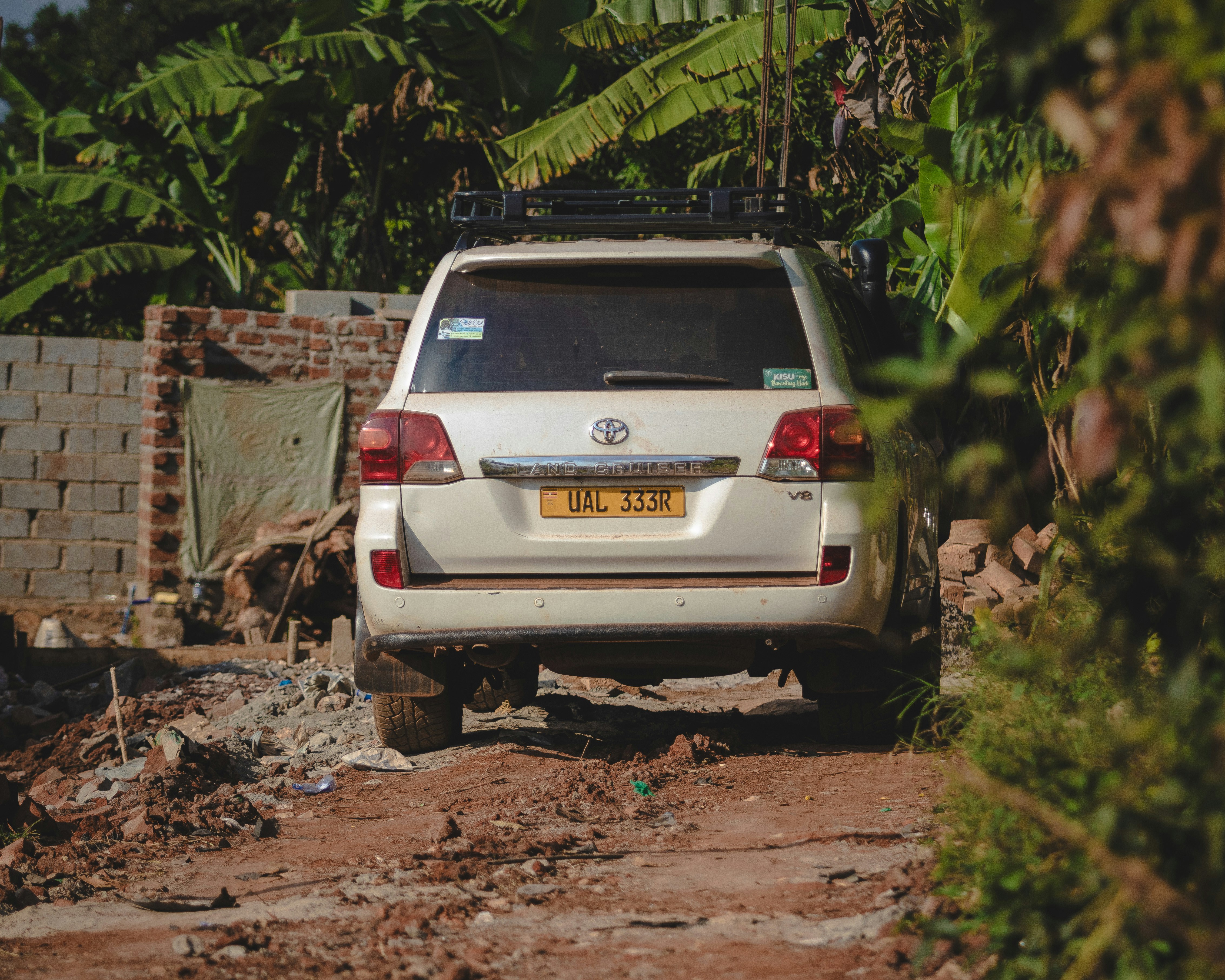 Rugged off-road rear: a weathered Toyota SUV resting on a dirt track