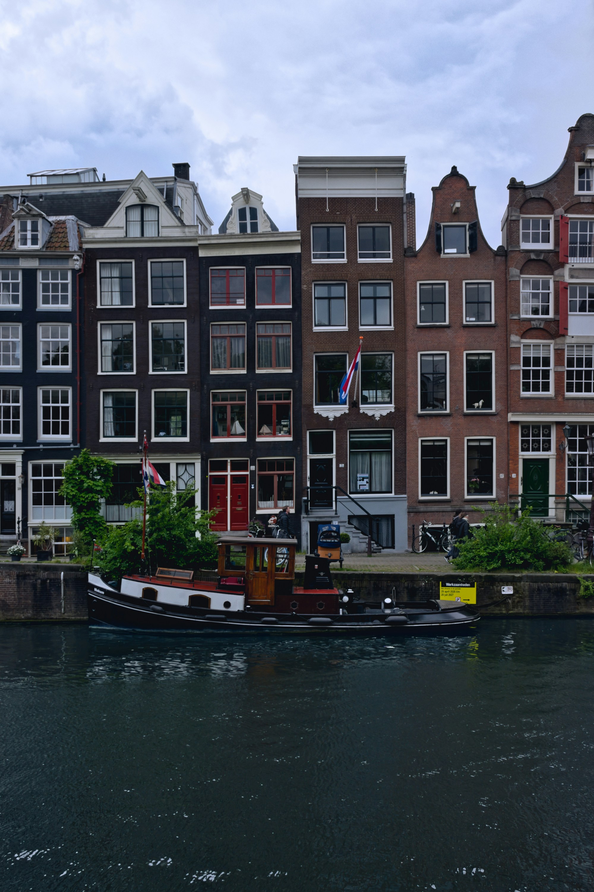 Canalfront Row: Classic Dutch Facades and a Working Boat