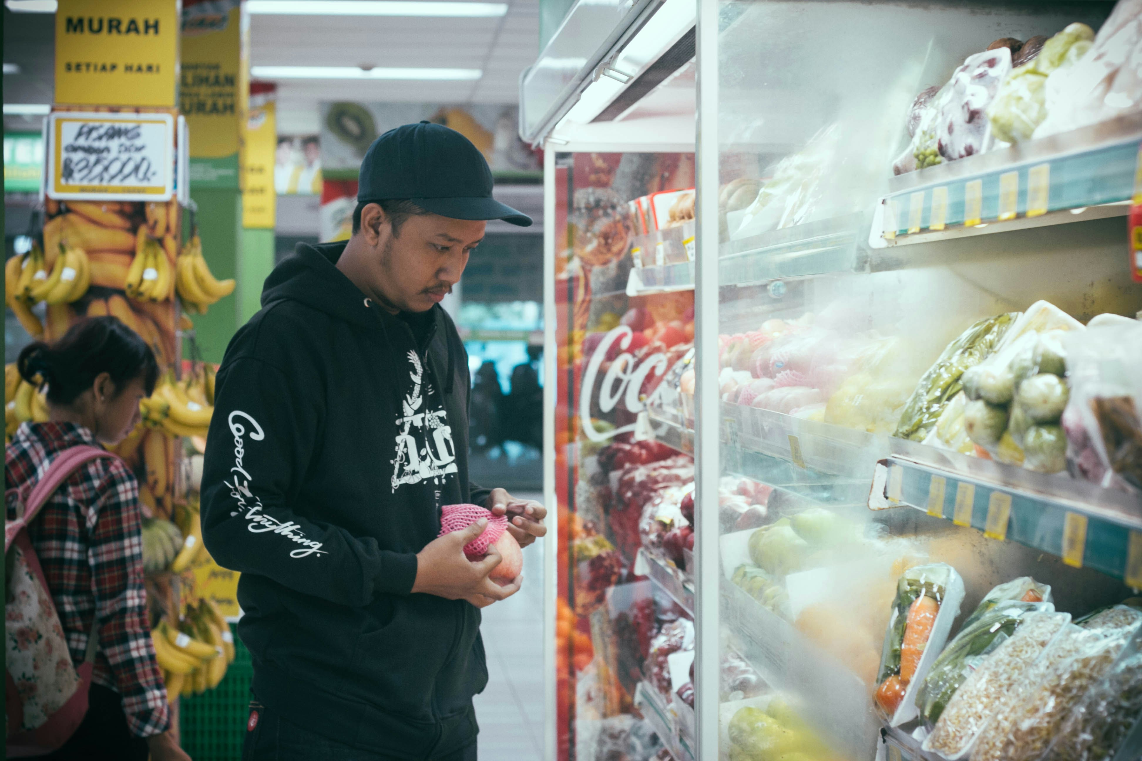 Mid-Aisle Focus: A Quiet Moment with the Fruit Stand