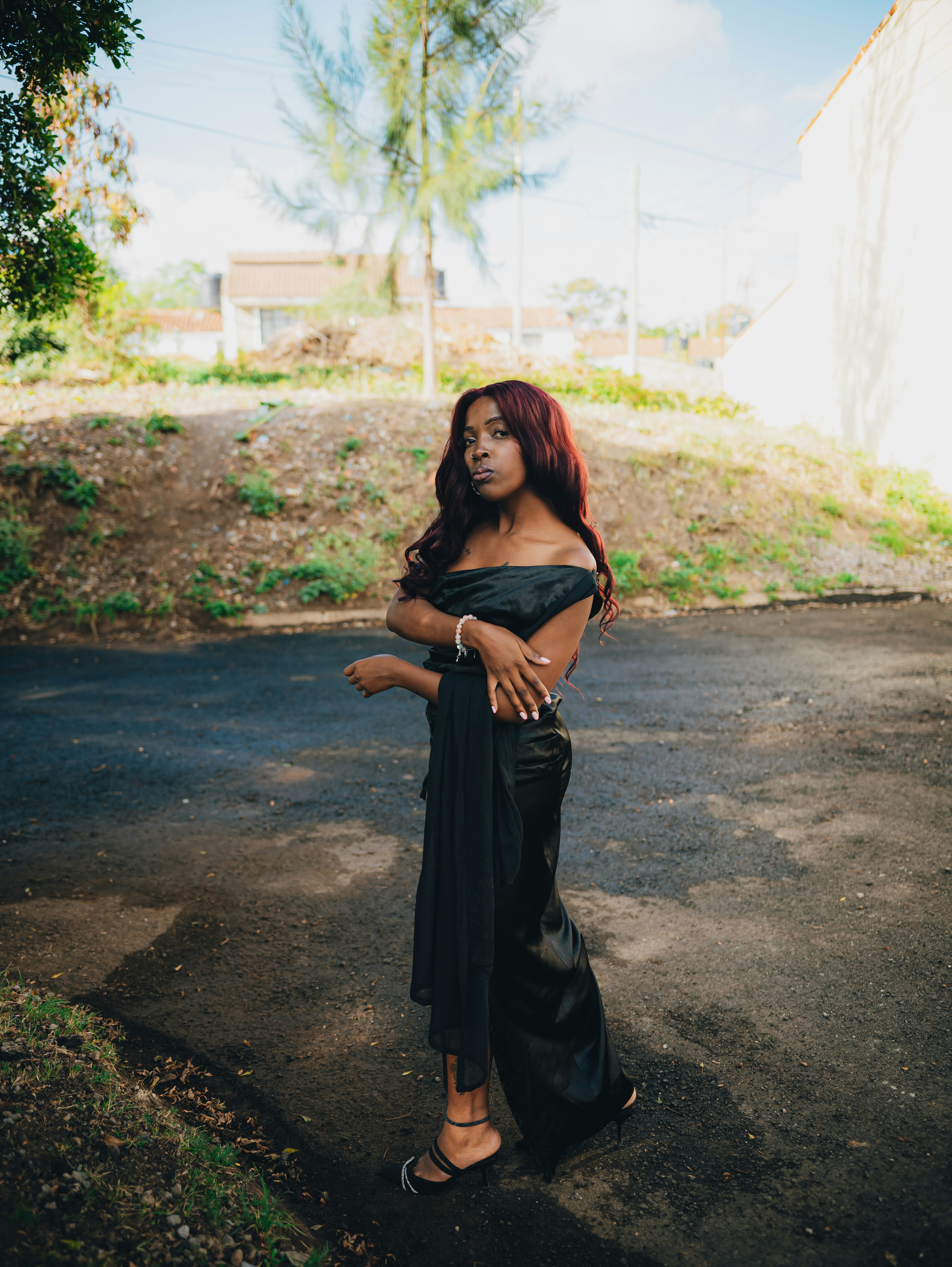 Elegance in Oblique Light: A Dressed Portrait in an Open Yard
