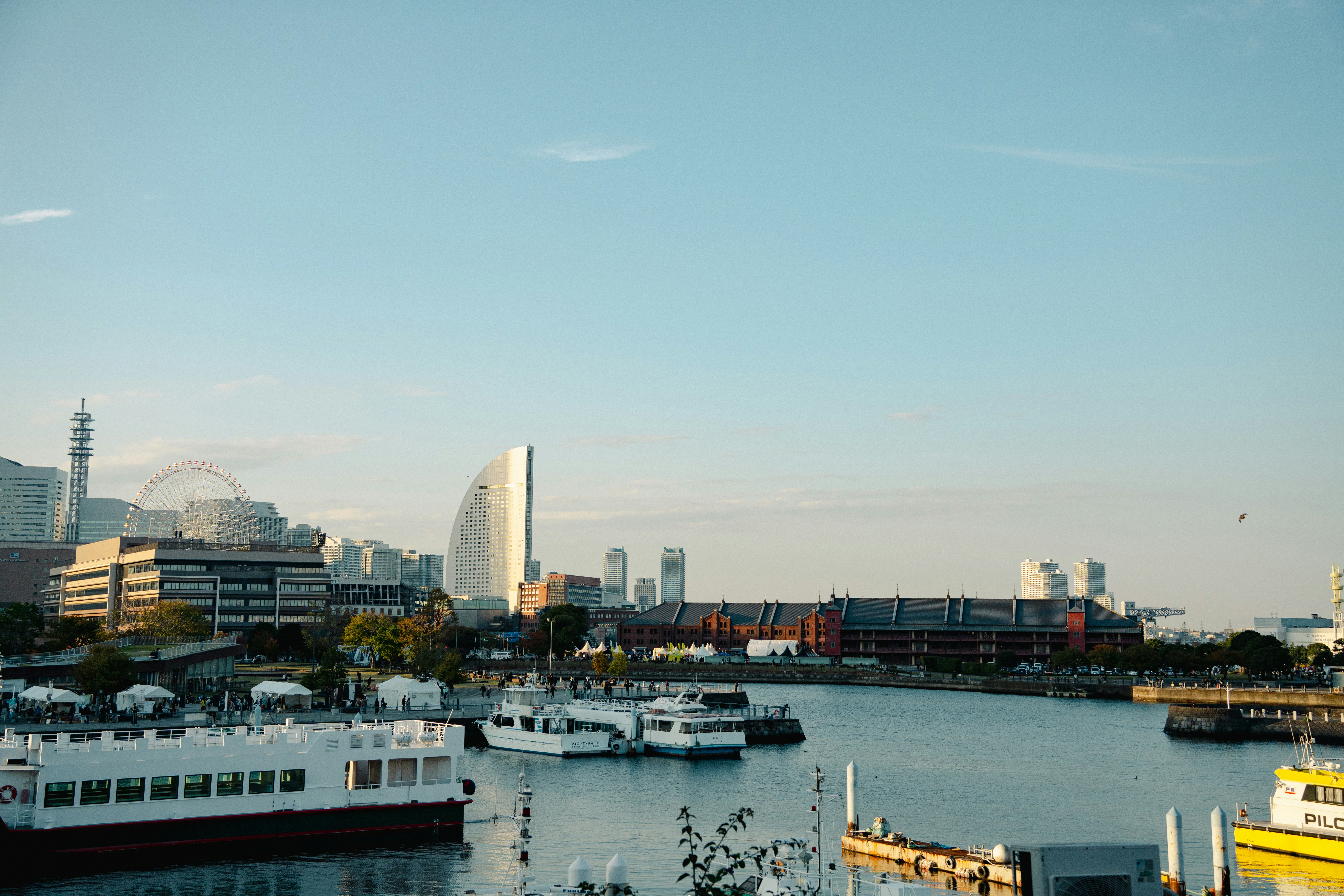 Harbor Silhouette: City skyline shadowed by calm water at golden hour
