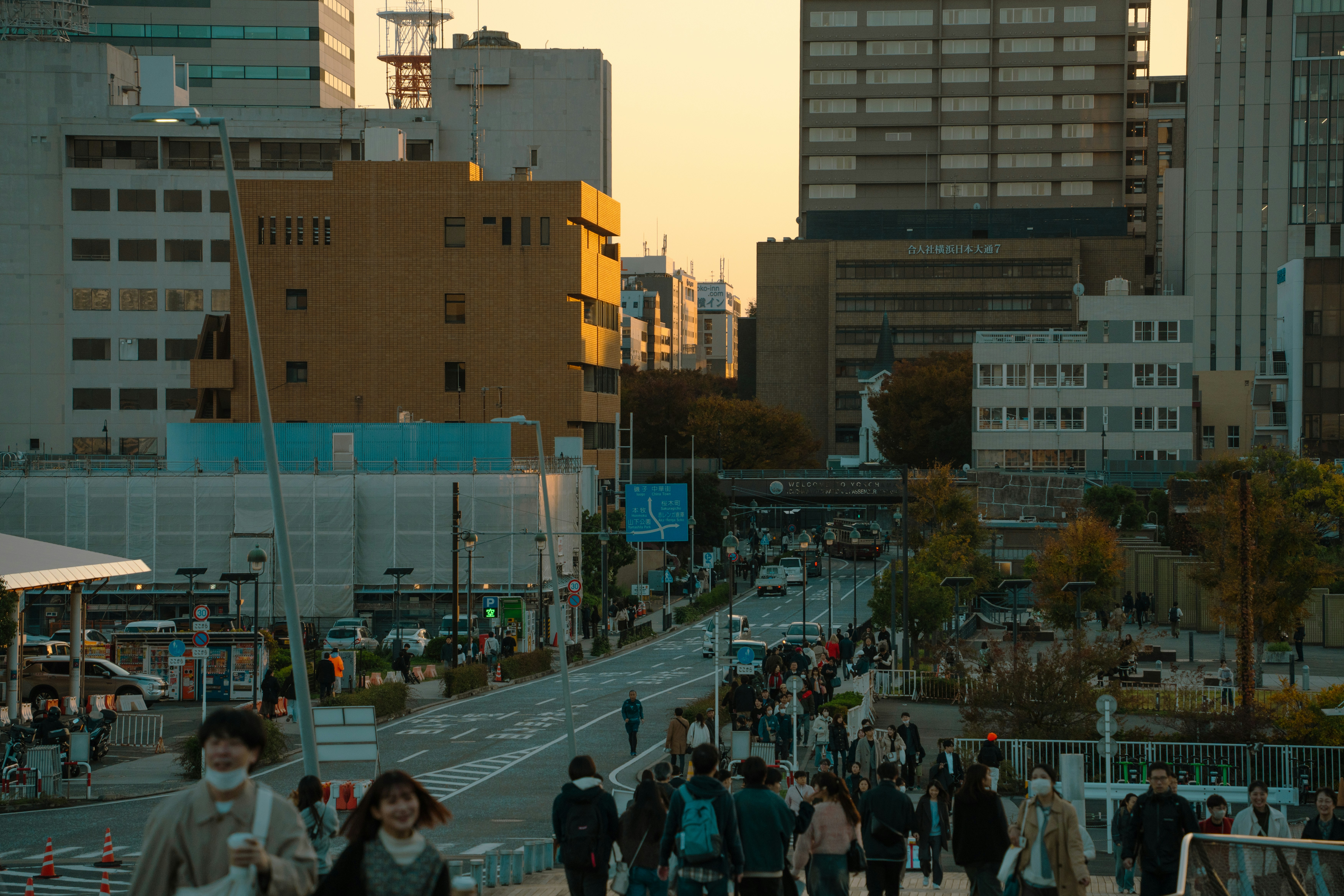 Urban Corridor at Golden Hour: Pedestrians Recede into a City Pulse