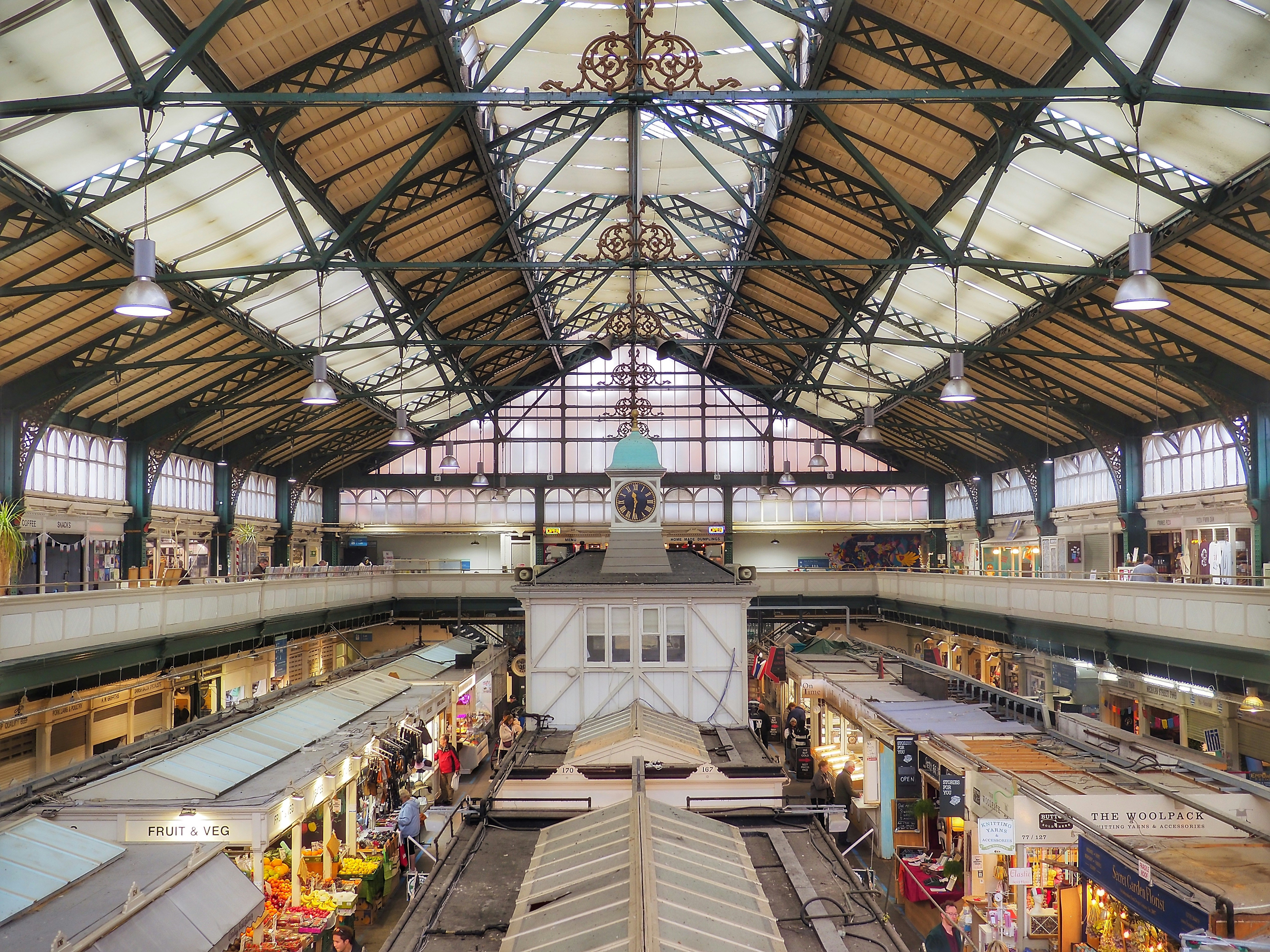 Central Clock Tower Under Glass Vault: A Moment in a European Market Hall