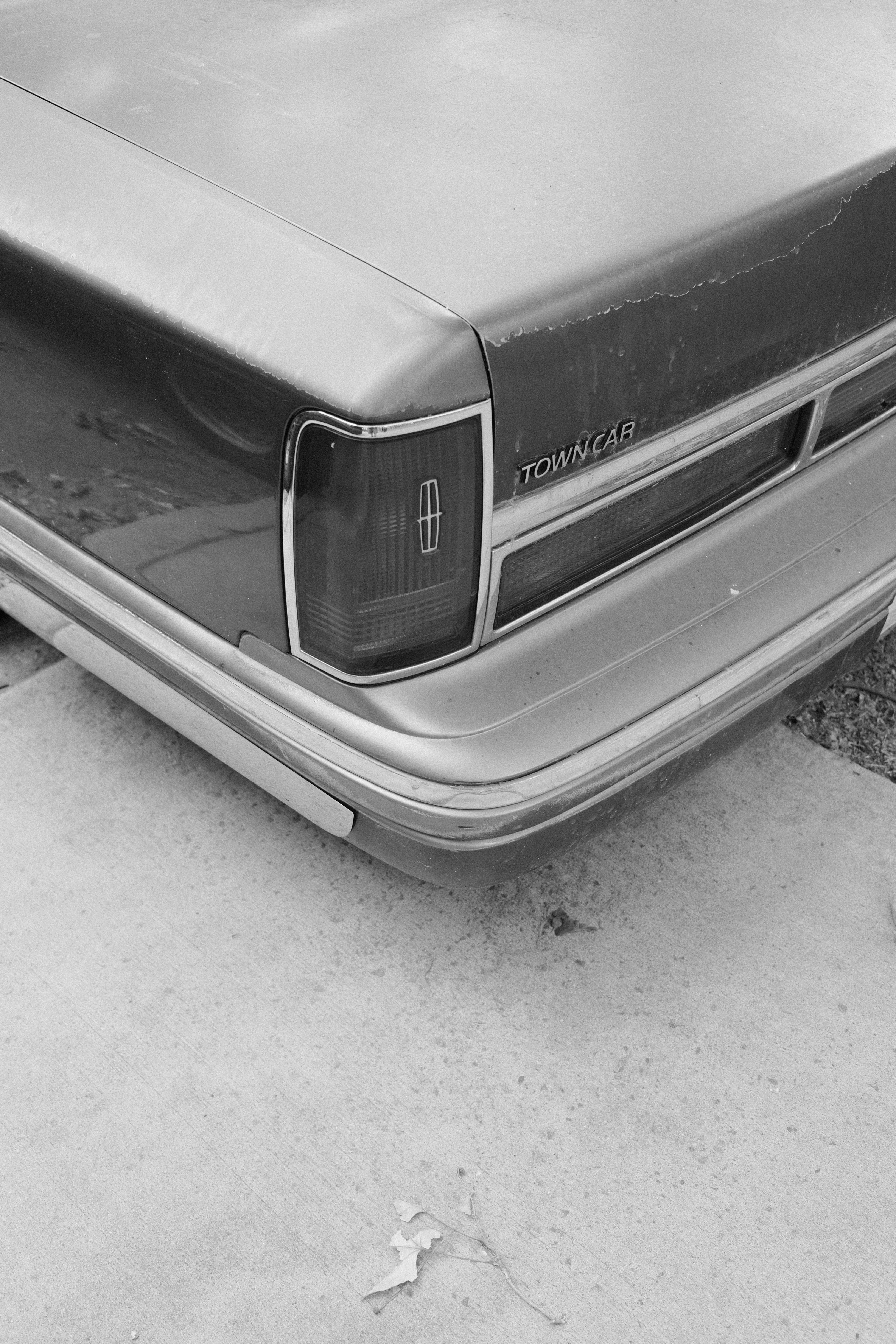 Tail Light Echoes: A Quiet Car Corner in Monochrome