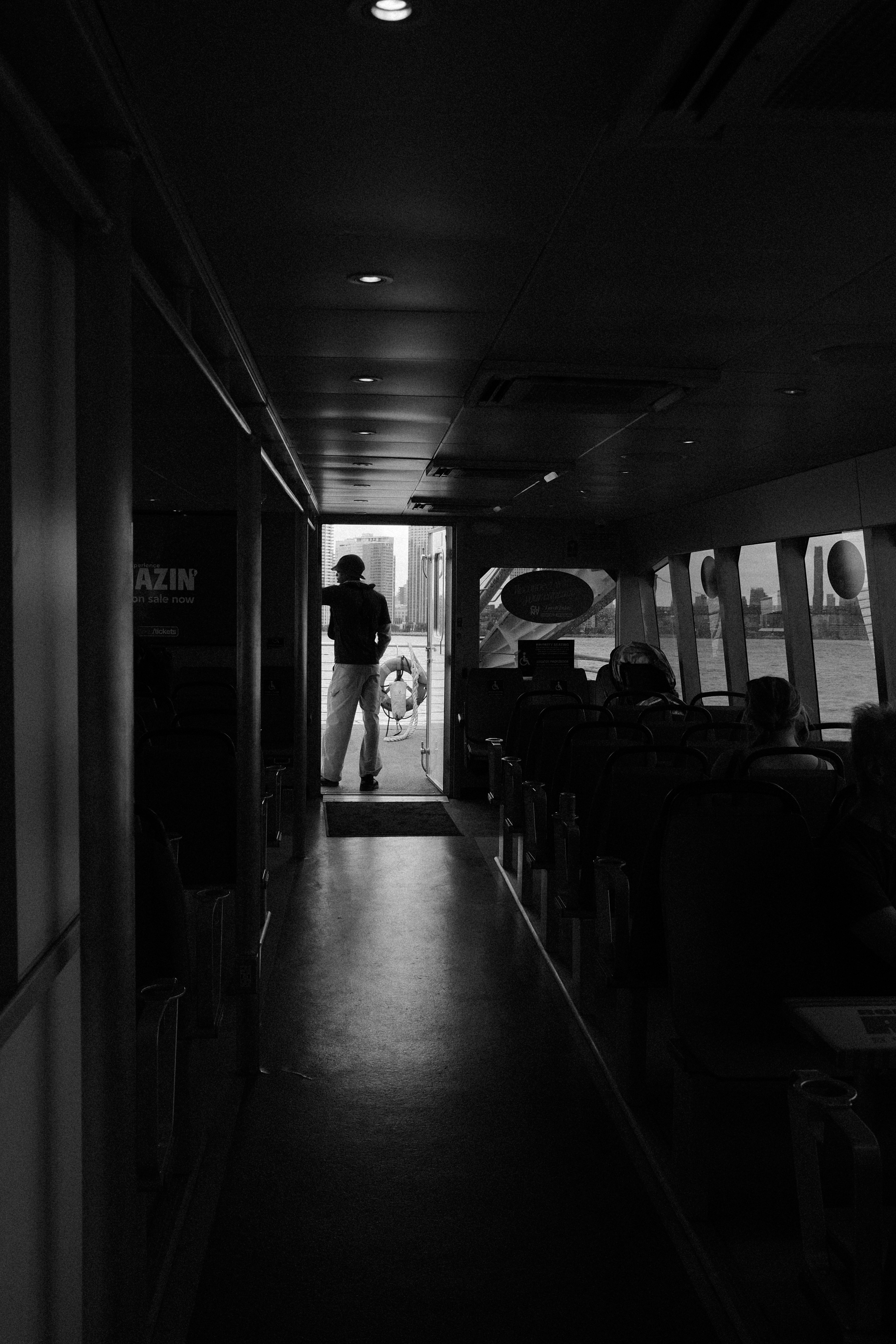 Rear-View Horizon: silhouette at the ferry’s doorway