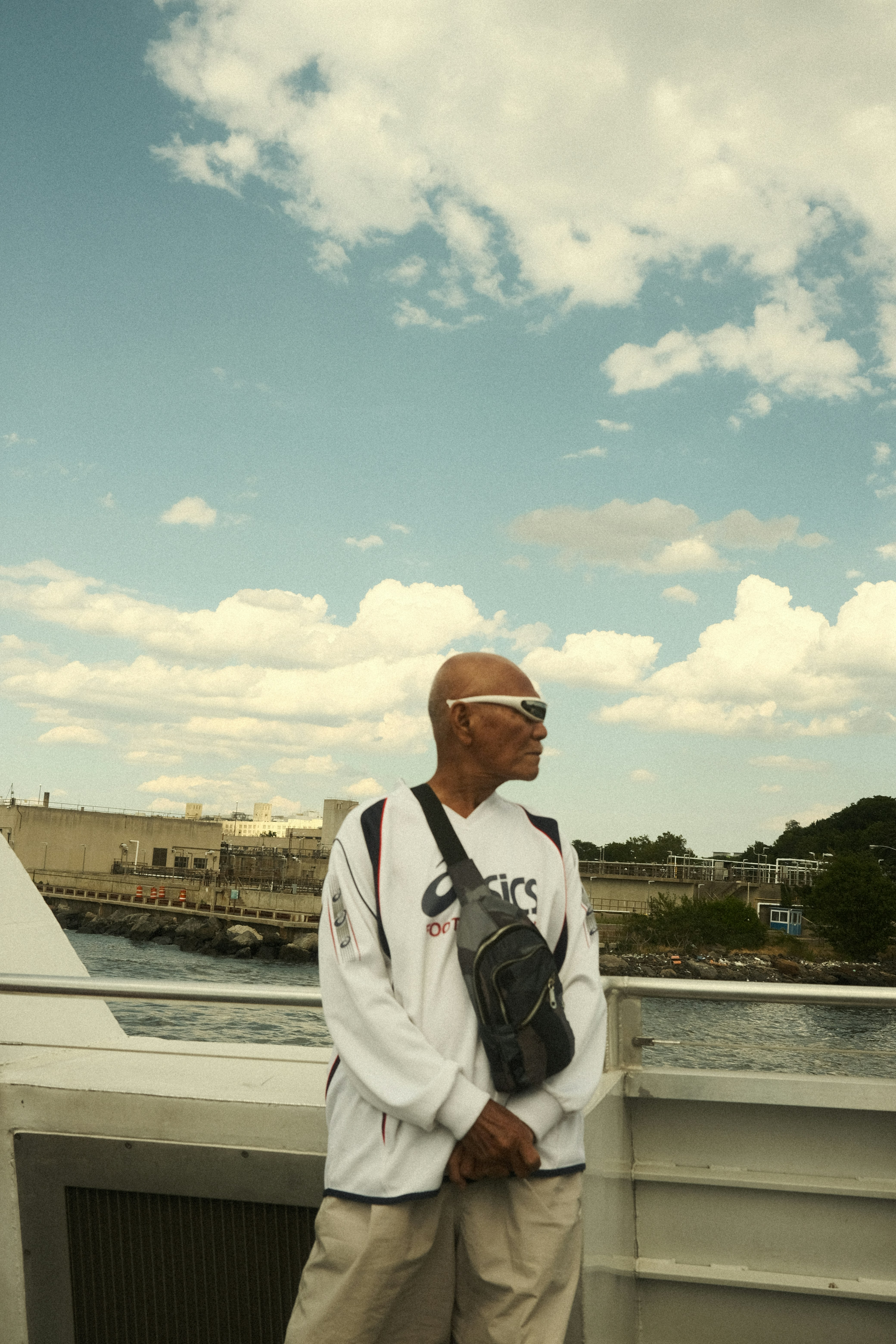 Coastal Promenade: A Quiet Moment with a Sunglassed Stranger