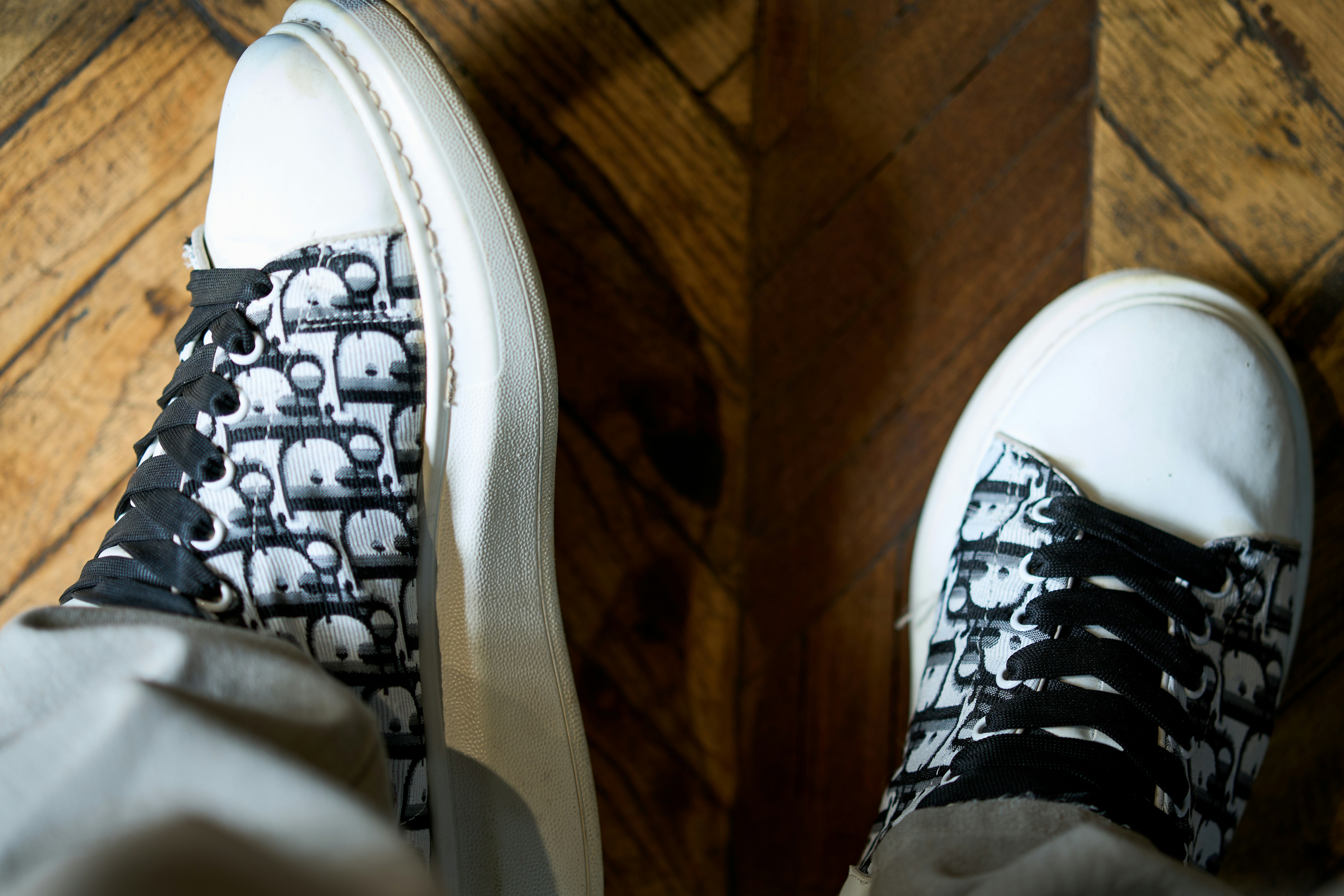 Low-angle Step: Patterned Sneakers Anchored on a Wooden Floor