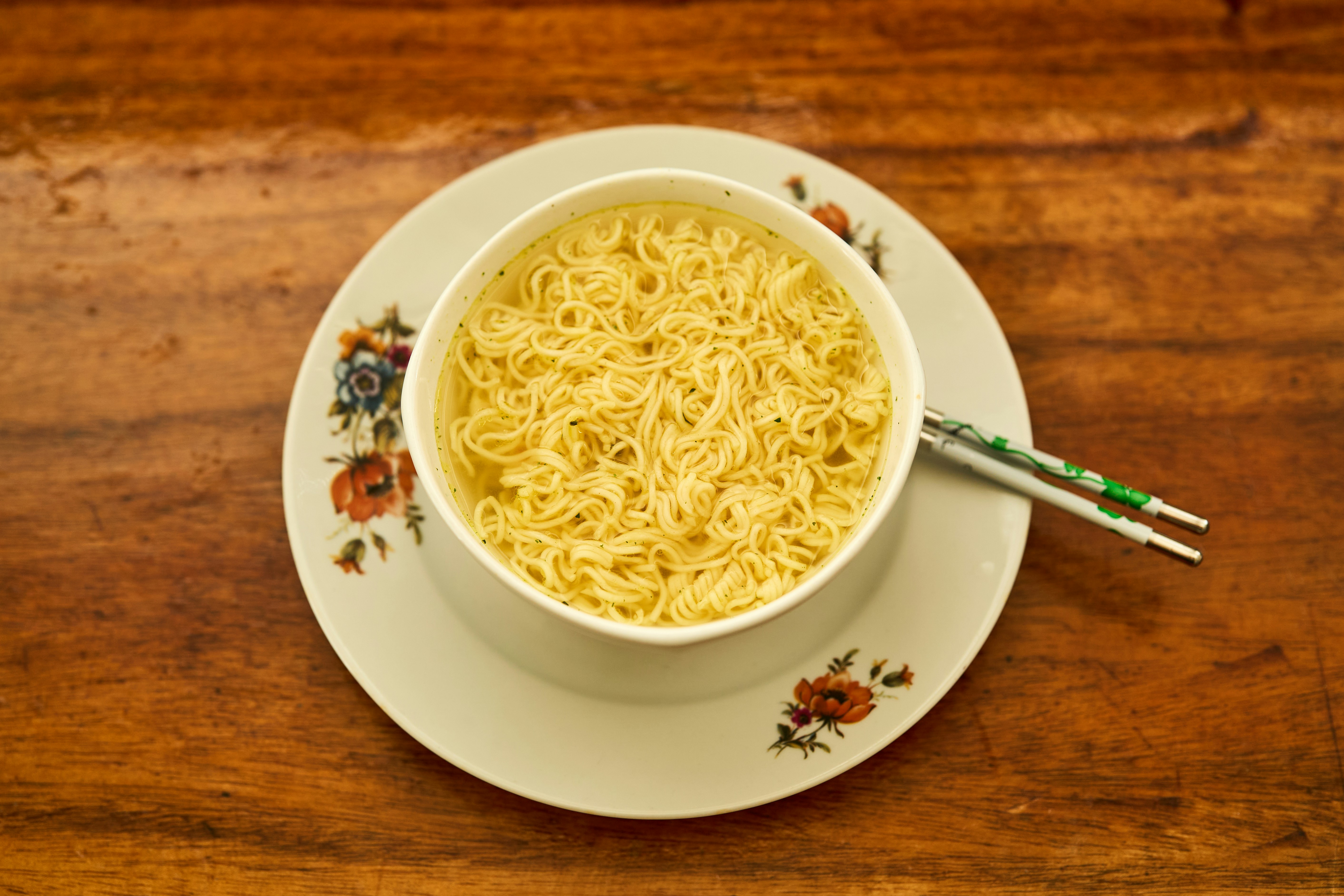 Quiet Bowl: Noodles on a Weathered Table