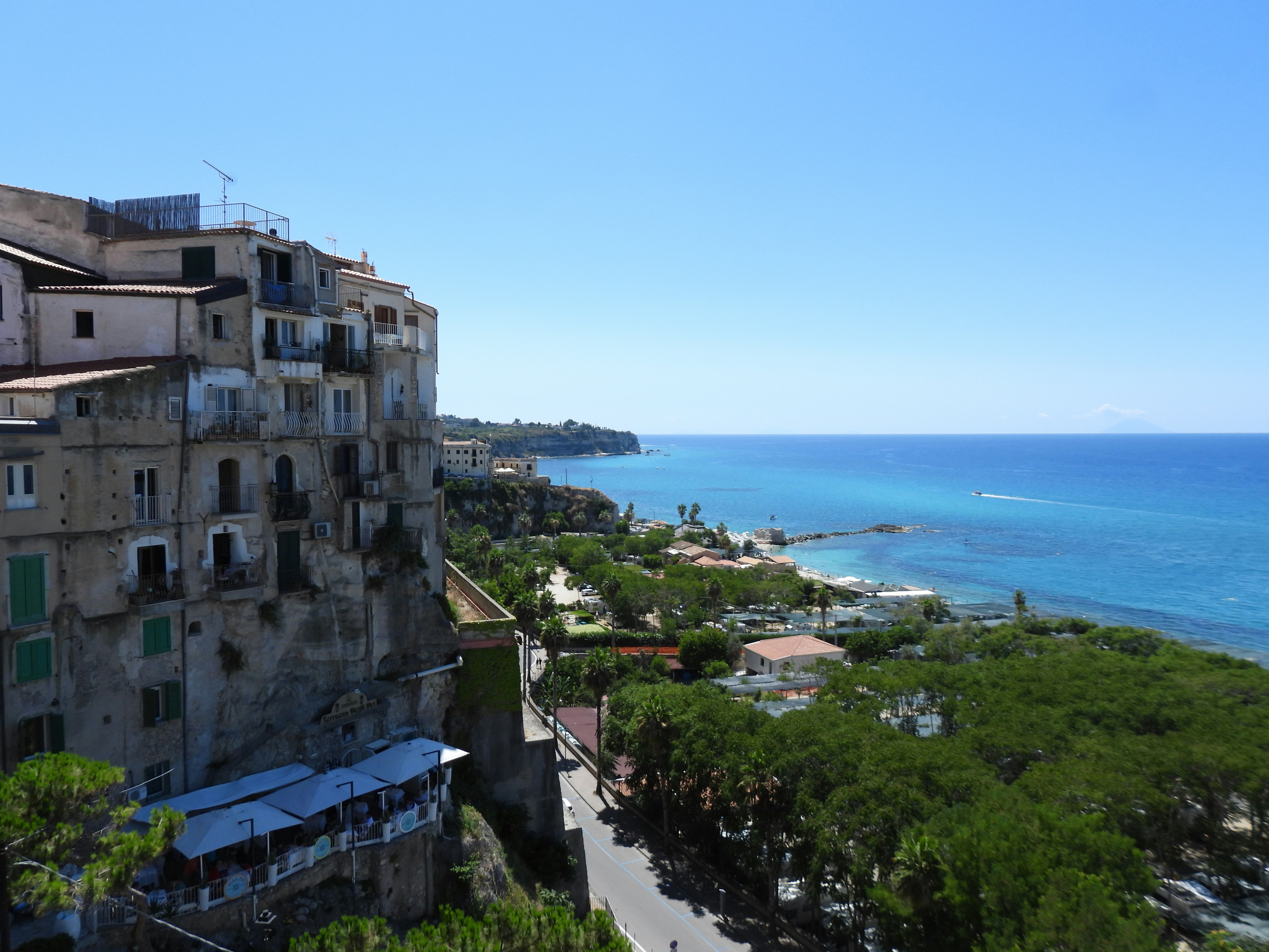 Clifftop Village Looms Over a Turquoise Sea