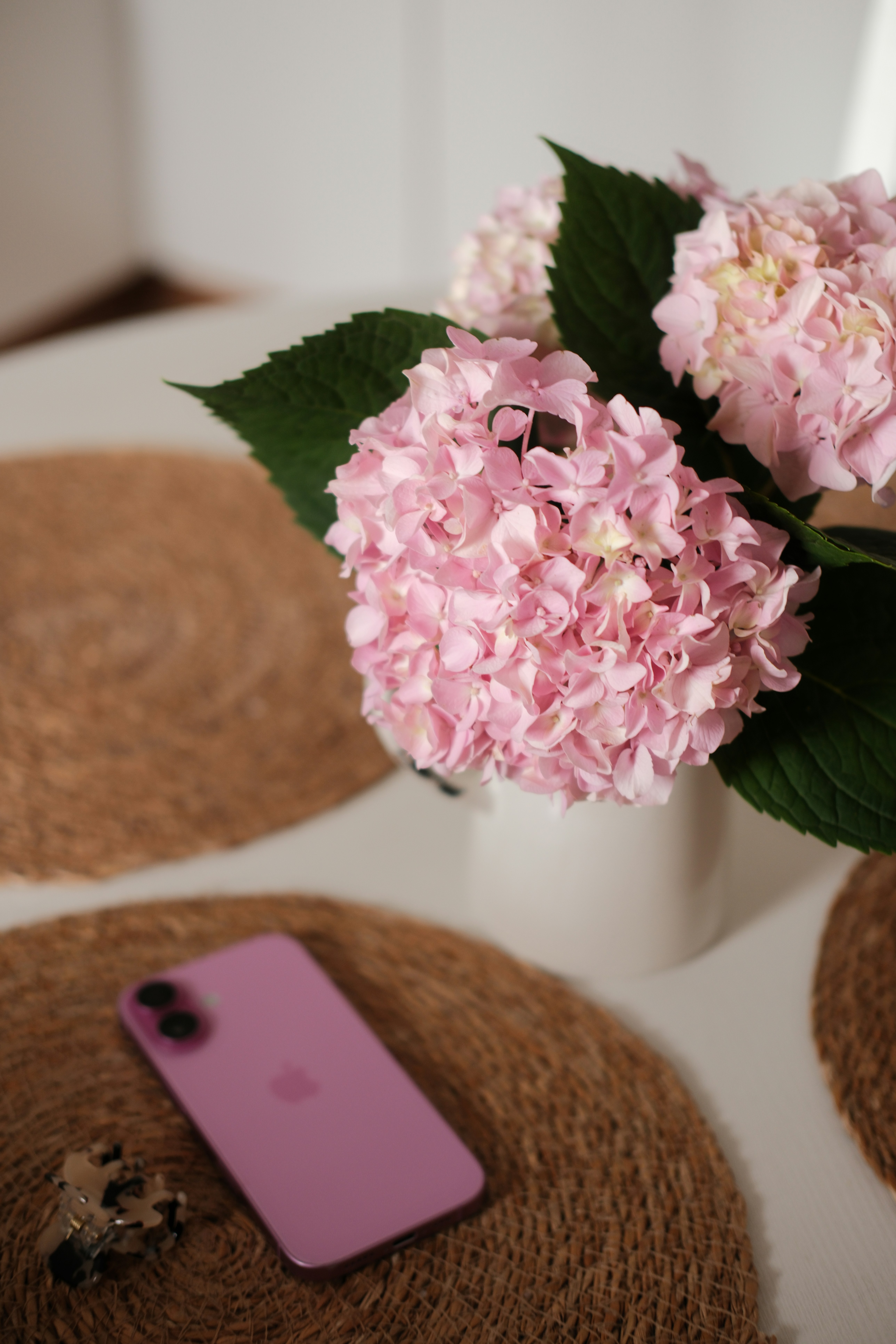 Pink Hydrangea Still Life with Lavender iPhone on Woven Placemats
