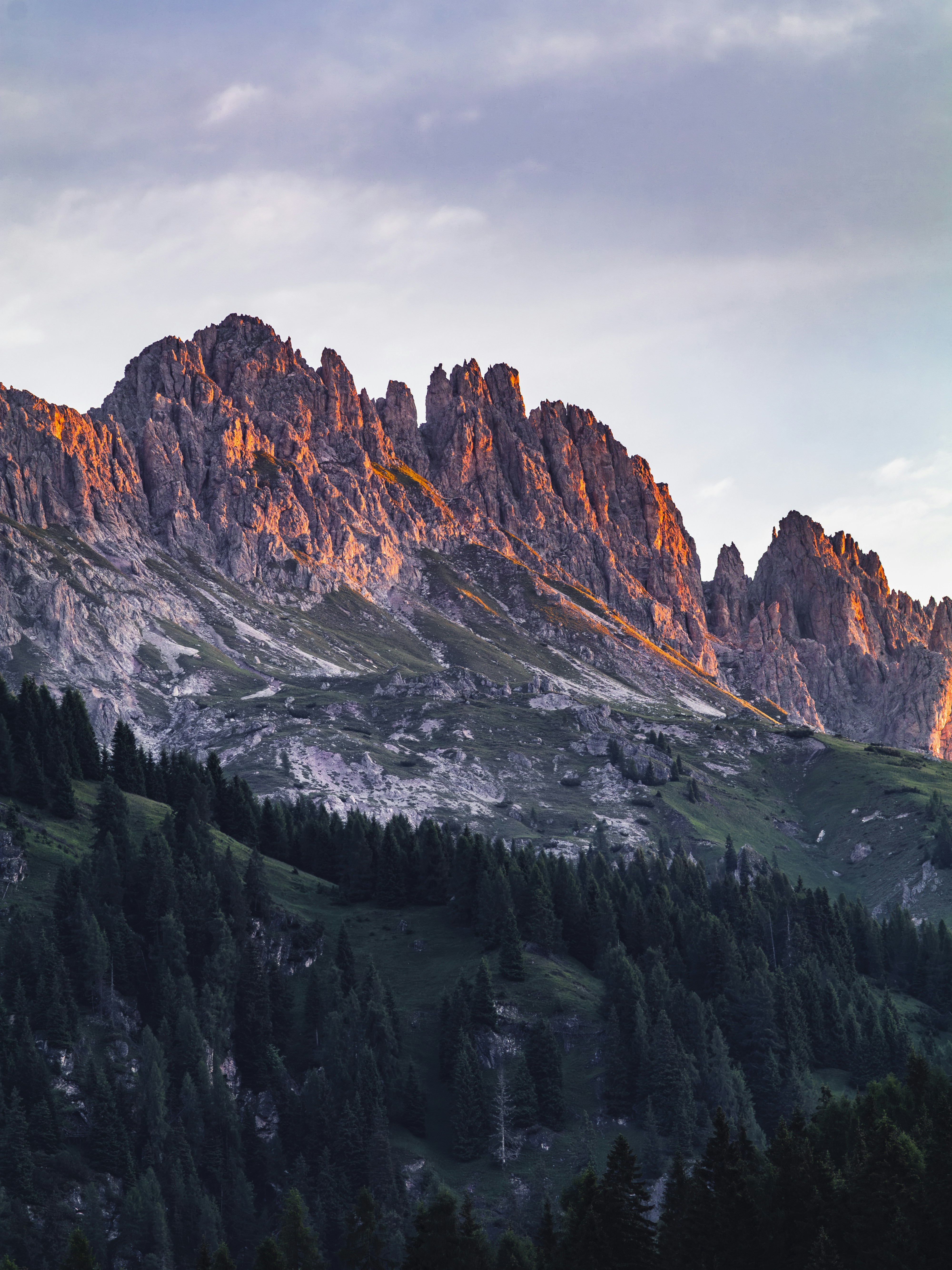 Sunlit Ridge: Fiery Peaks Over a Green Valley