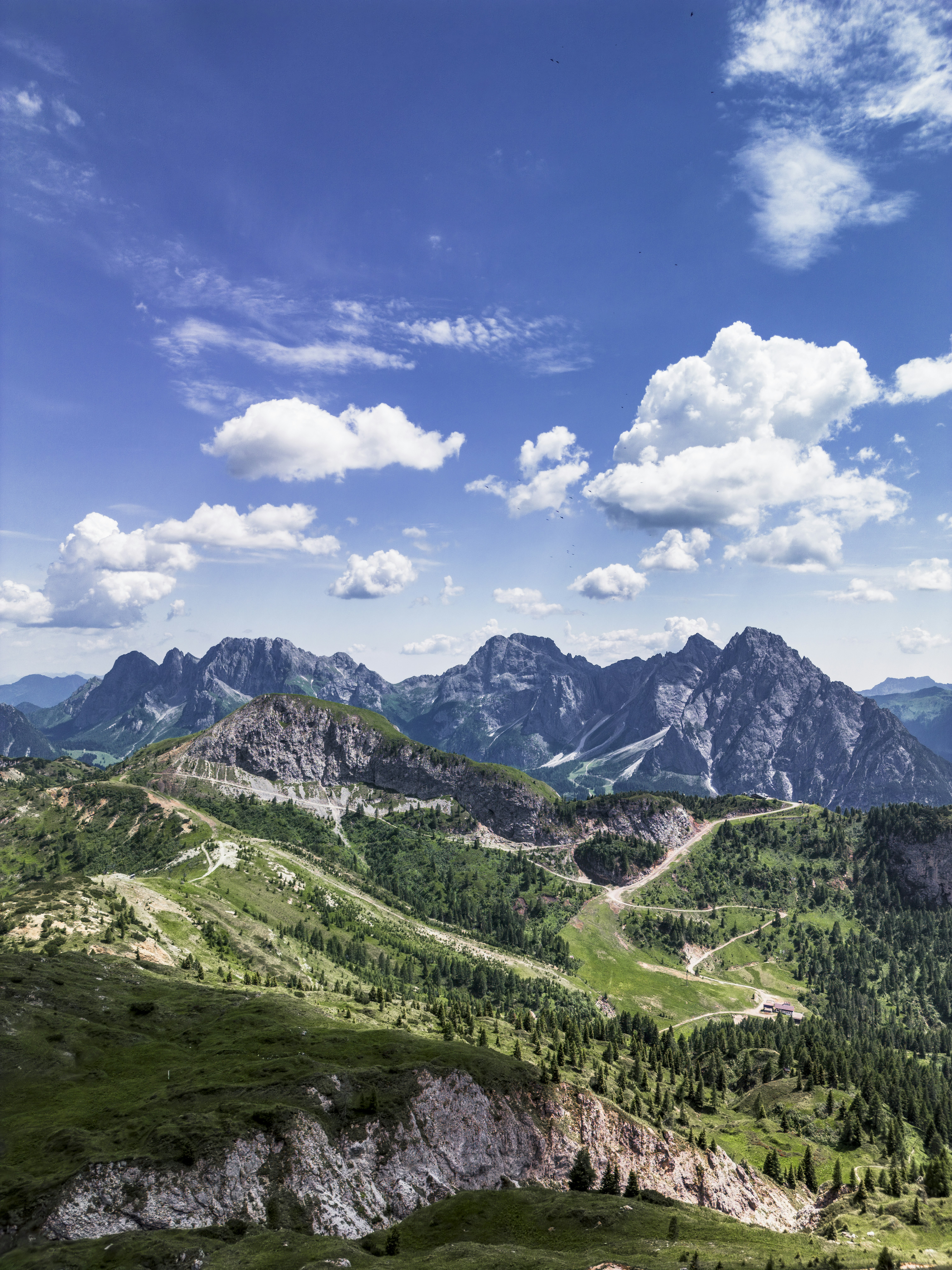 Mountain Crest Under a Sky of Puffed Clouds