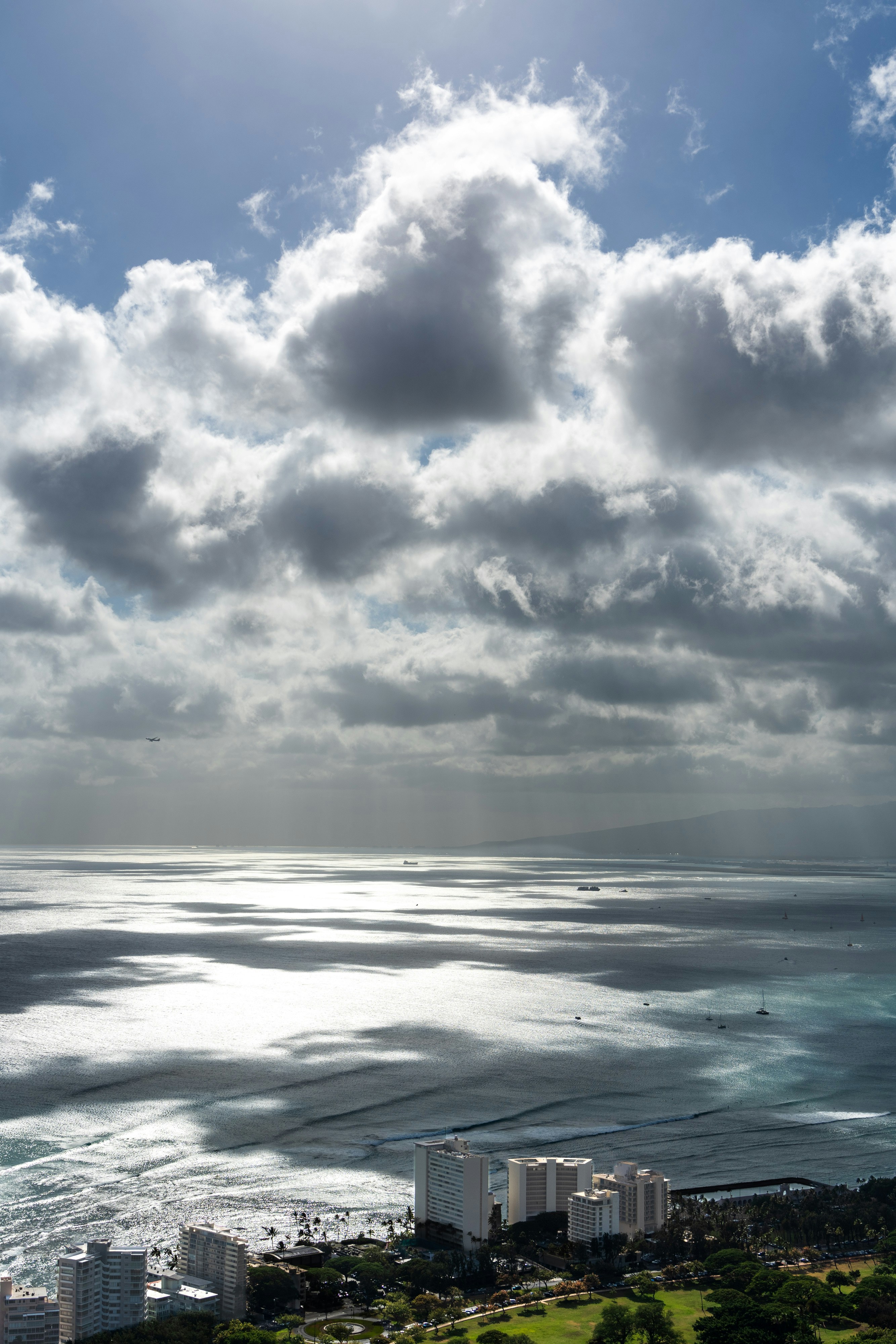 Sunlit Waves Over a Coastal Skyline