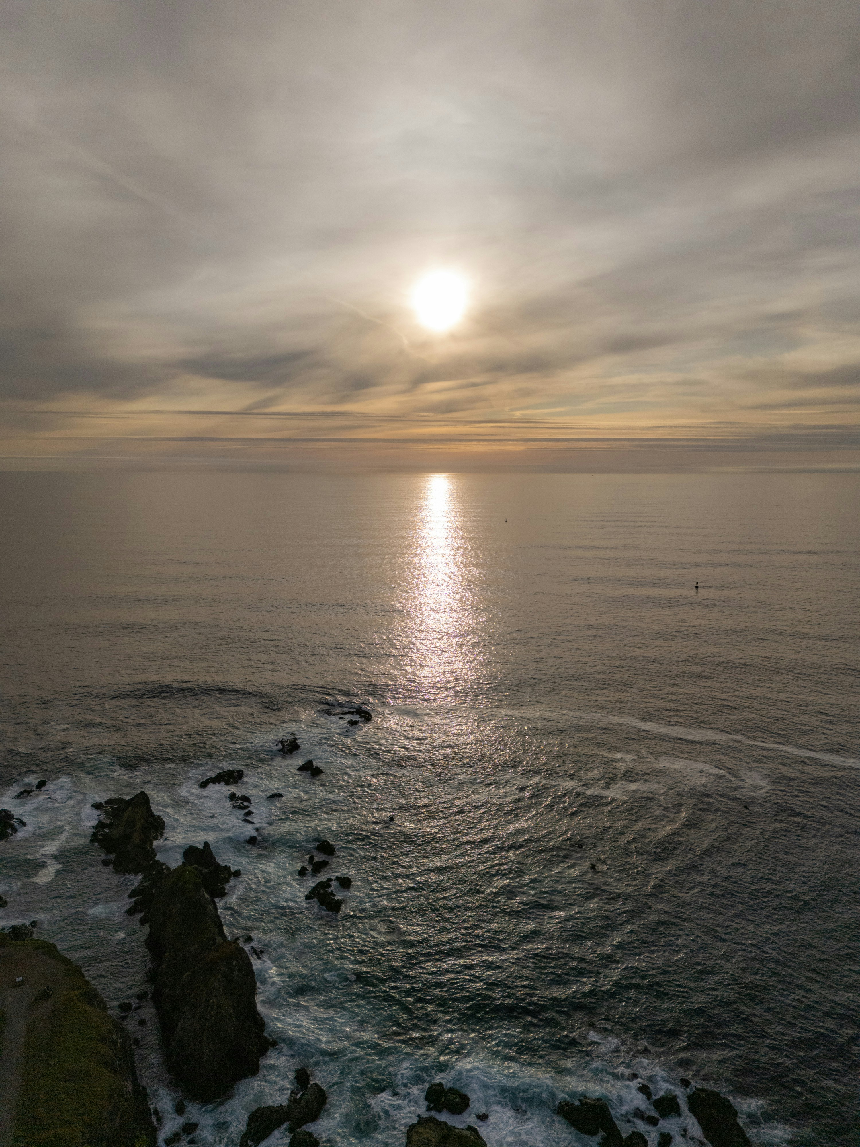 Sunlit Horizon Over Quiet Seas from Cliff Edge