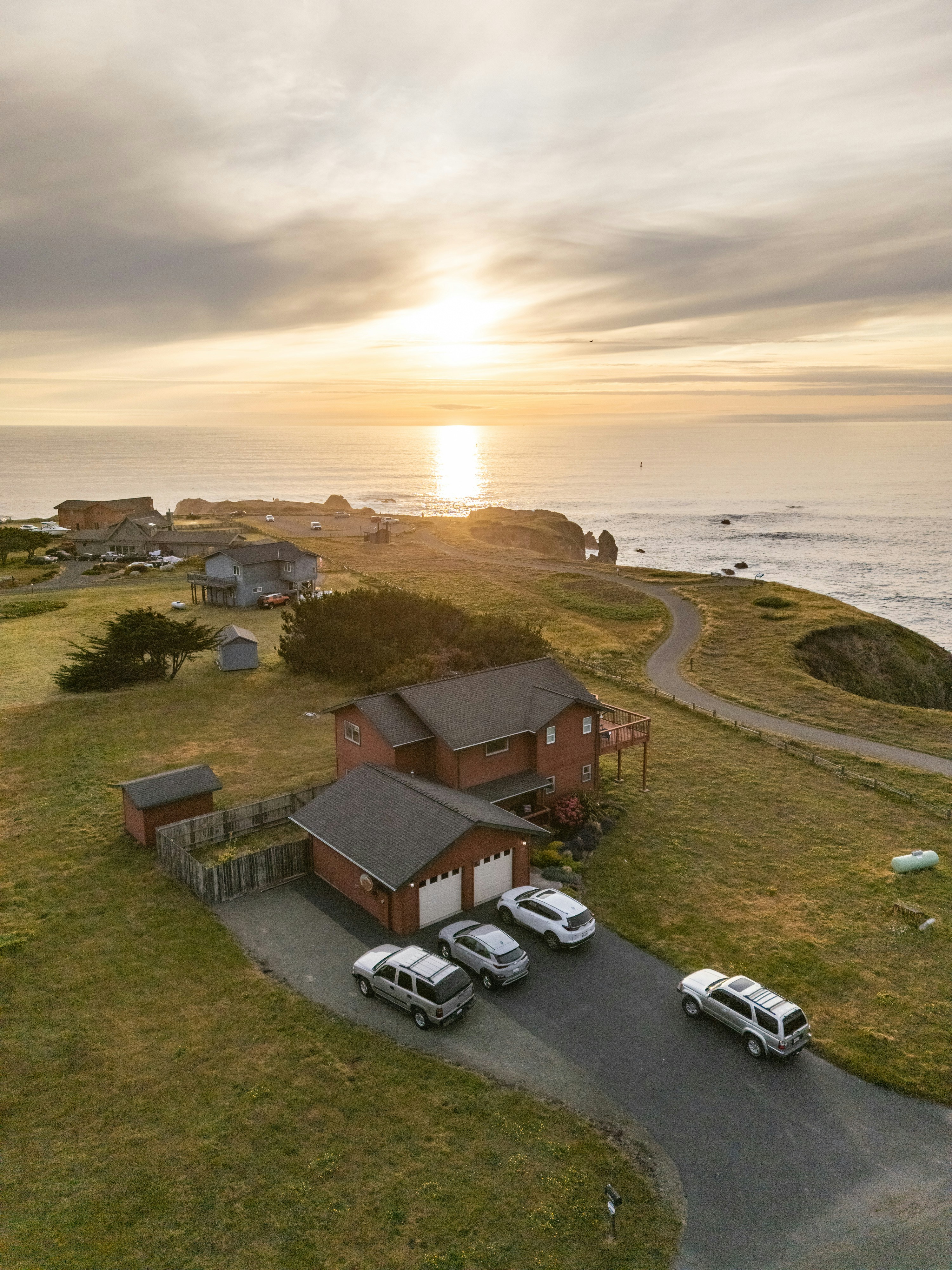 Sunlit Coastal Homestead Beneath a Quiet Horizon