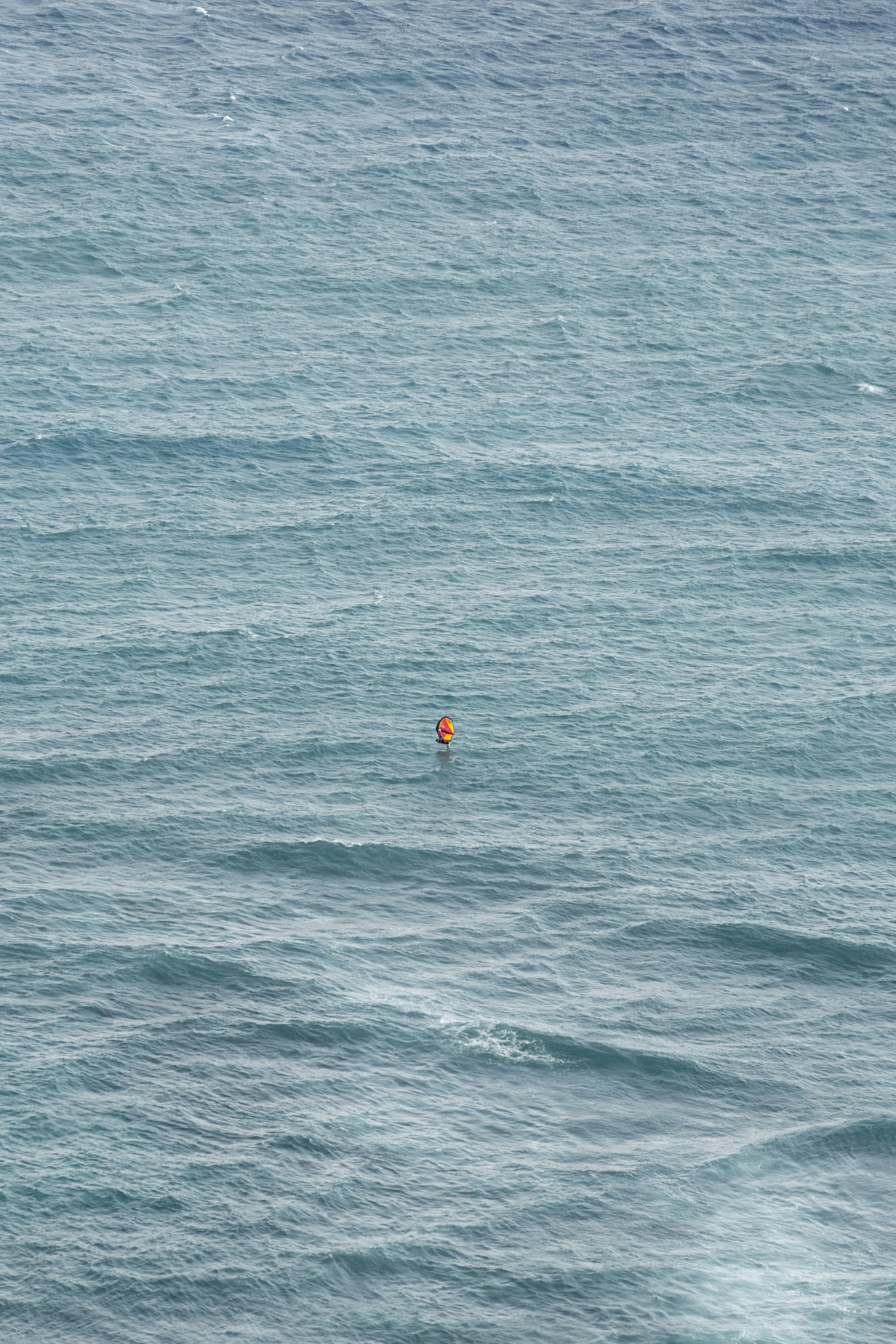 Floating Beacon: A lone buoy amid vast ocean swells