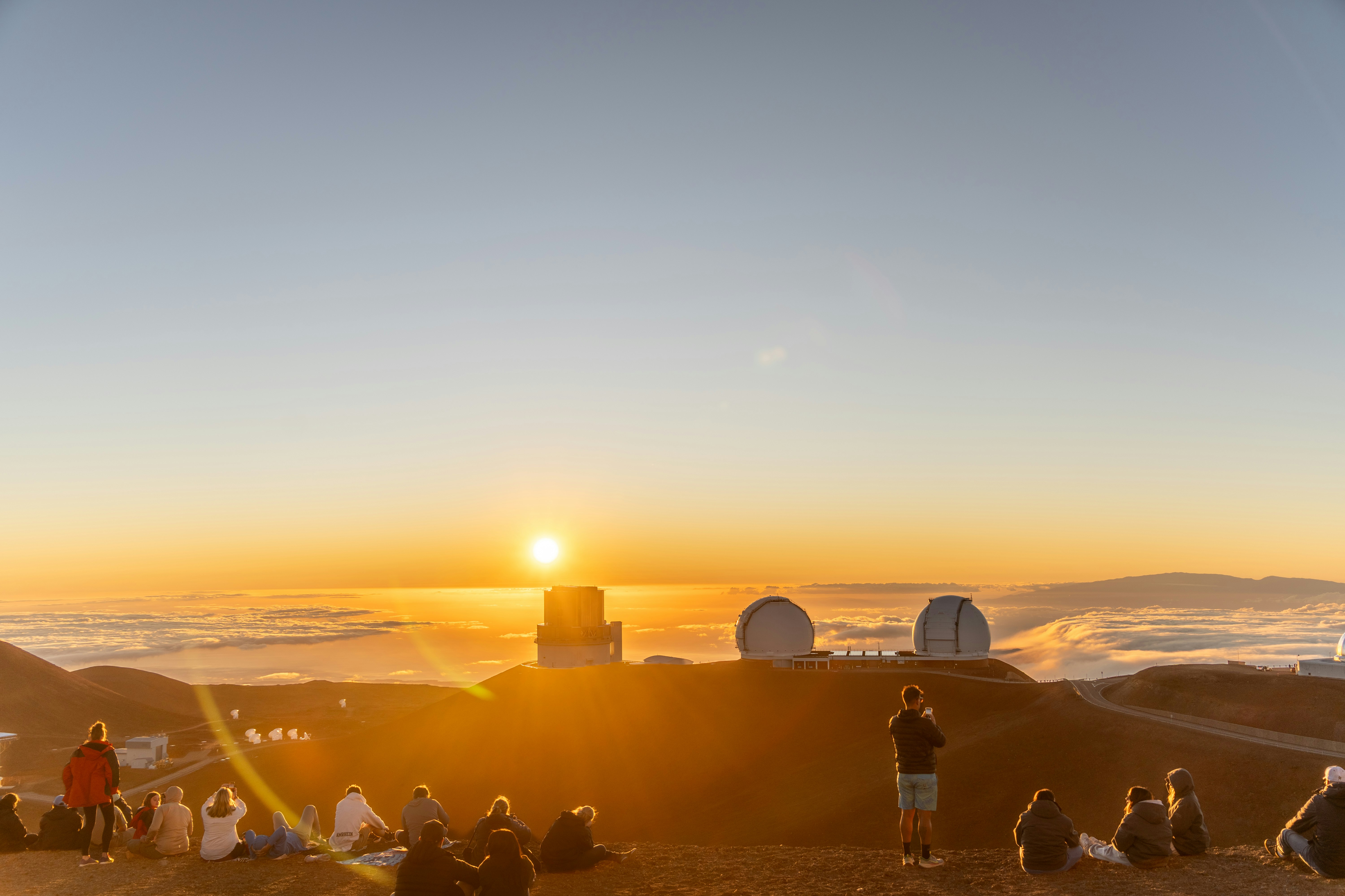 Sunset Observers at the Rim: People Silhouetted Against the Solar Halo
