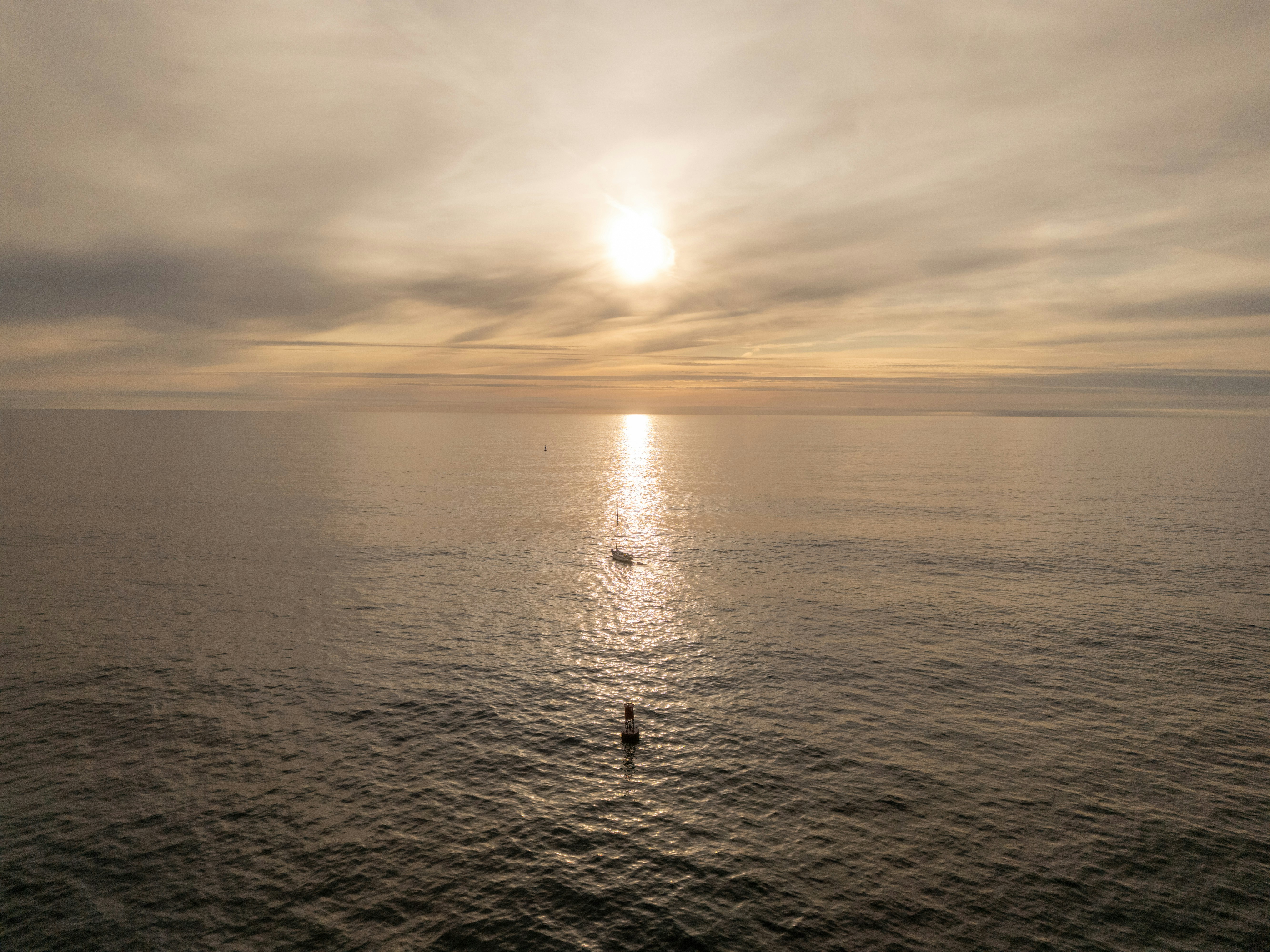 Sunlit Passage: Boats and Horizon at Dusk