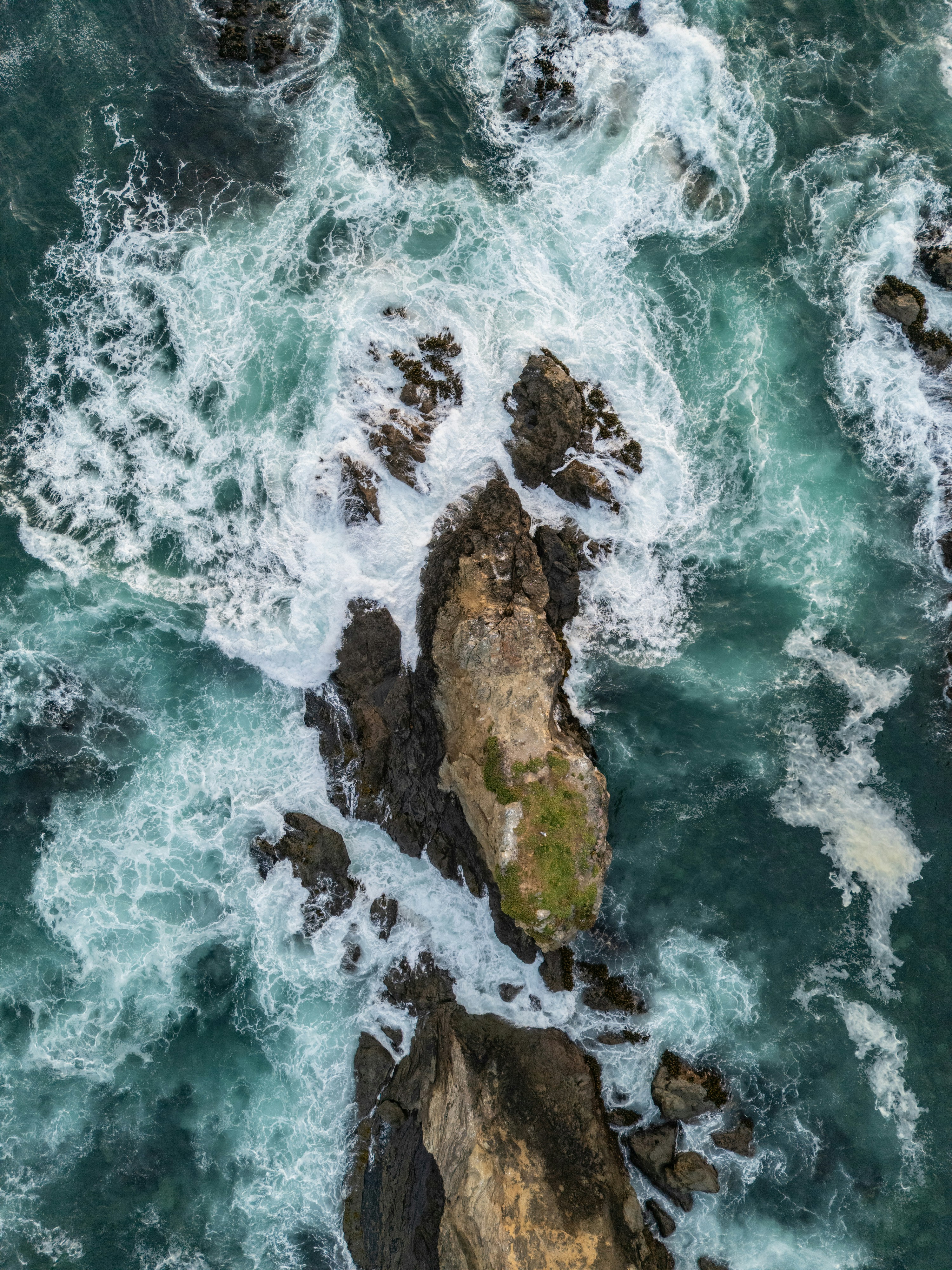 Rugged Rock Spine Cutting Through Turquoise Swell