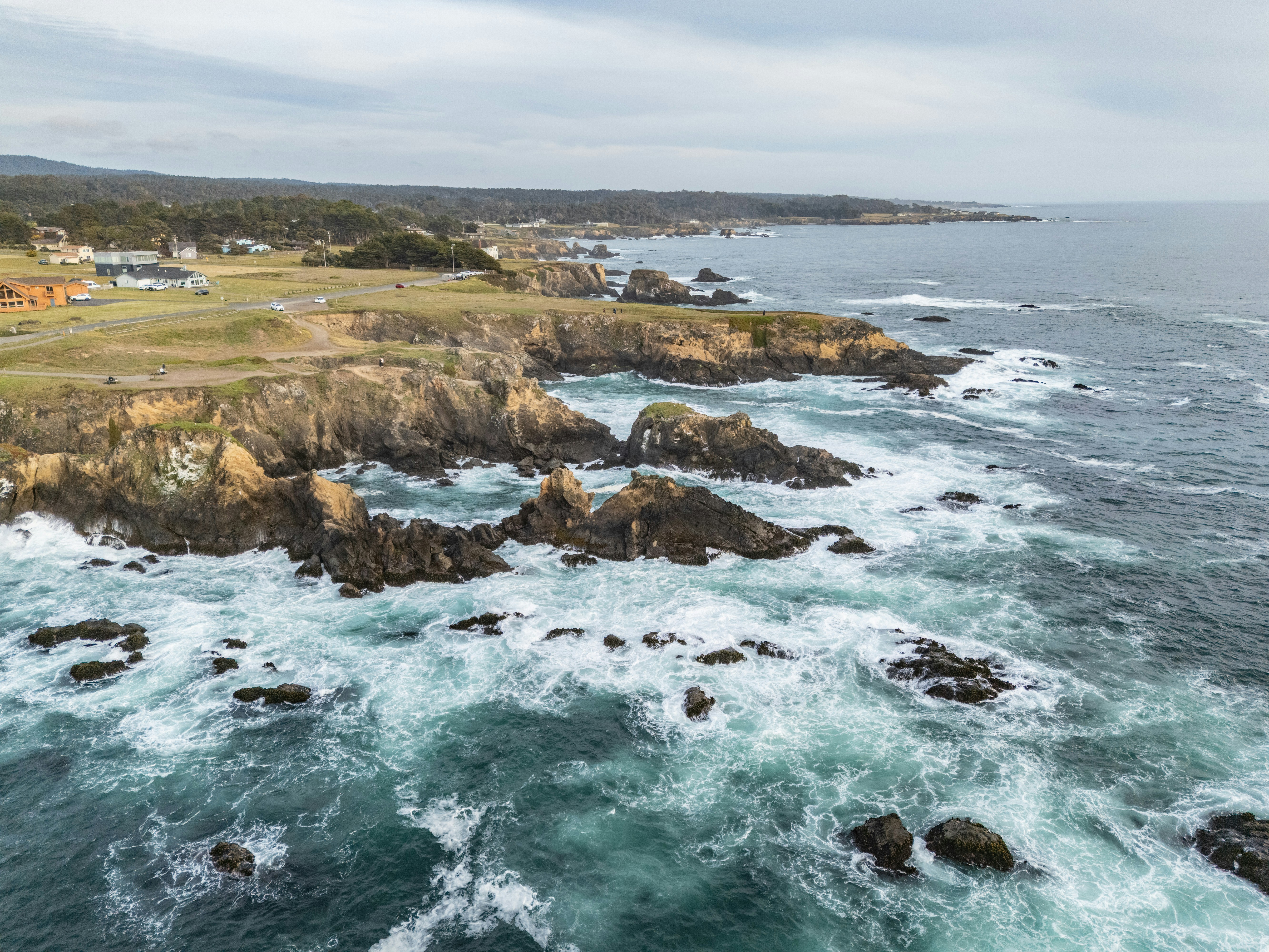 Rugged Coastline at Dusk: Waves Confront the Rocky Verge