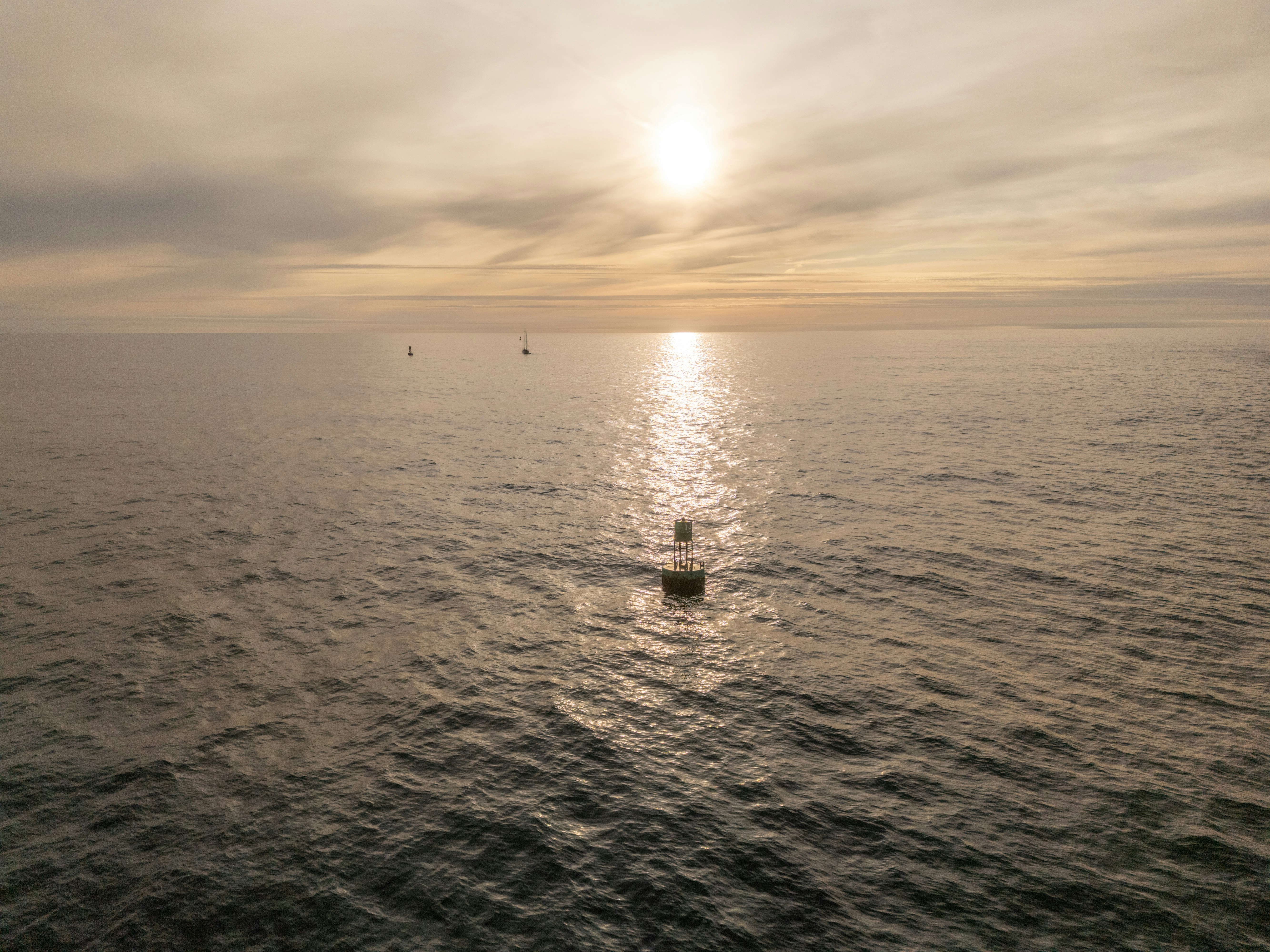 Golden Hour Over Quiet Seas: A Buoy and Distant Horizon