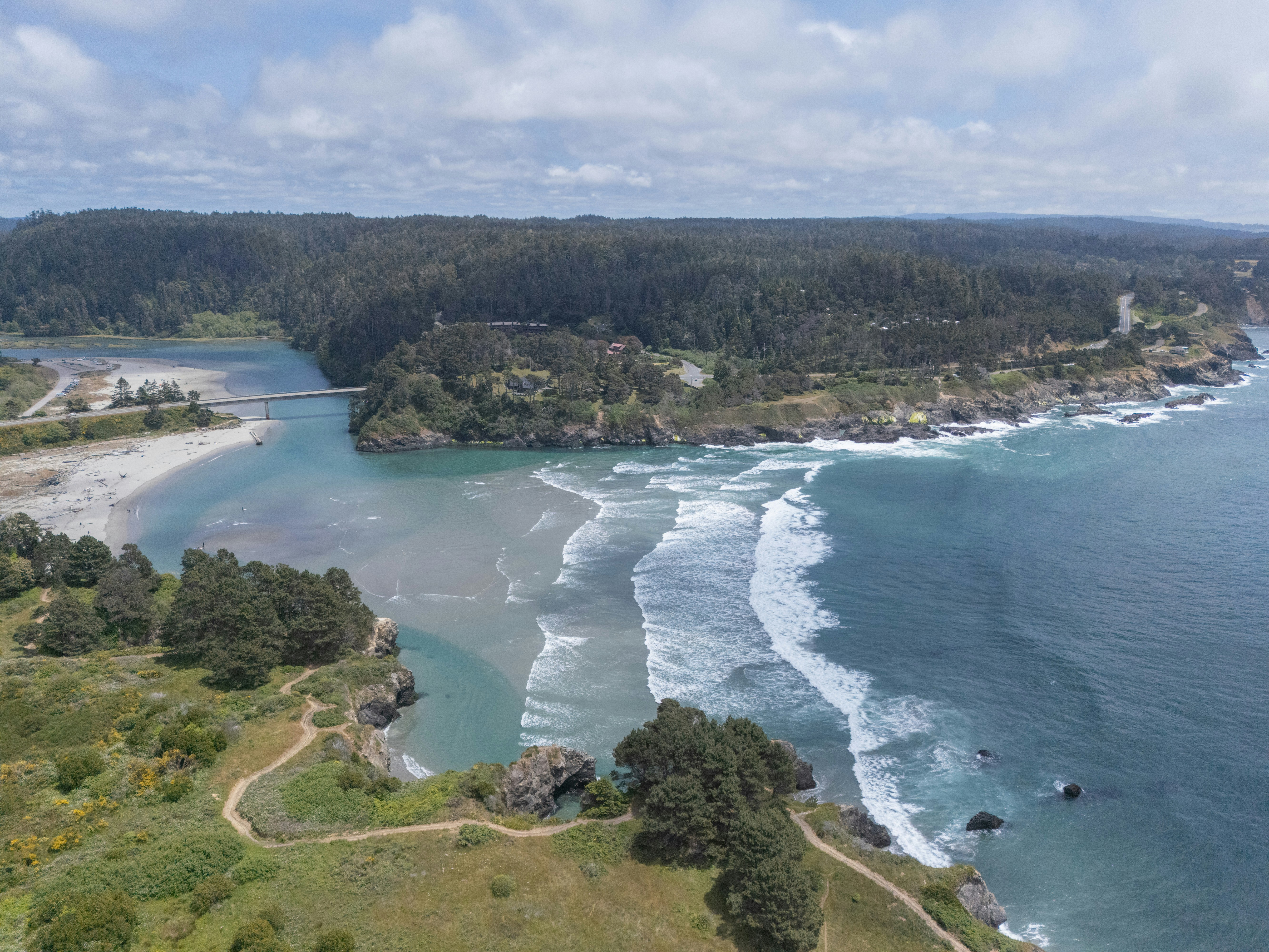 Coastal headland and beach bend from a sea-level vantage