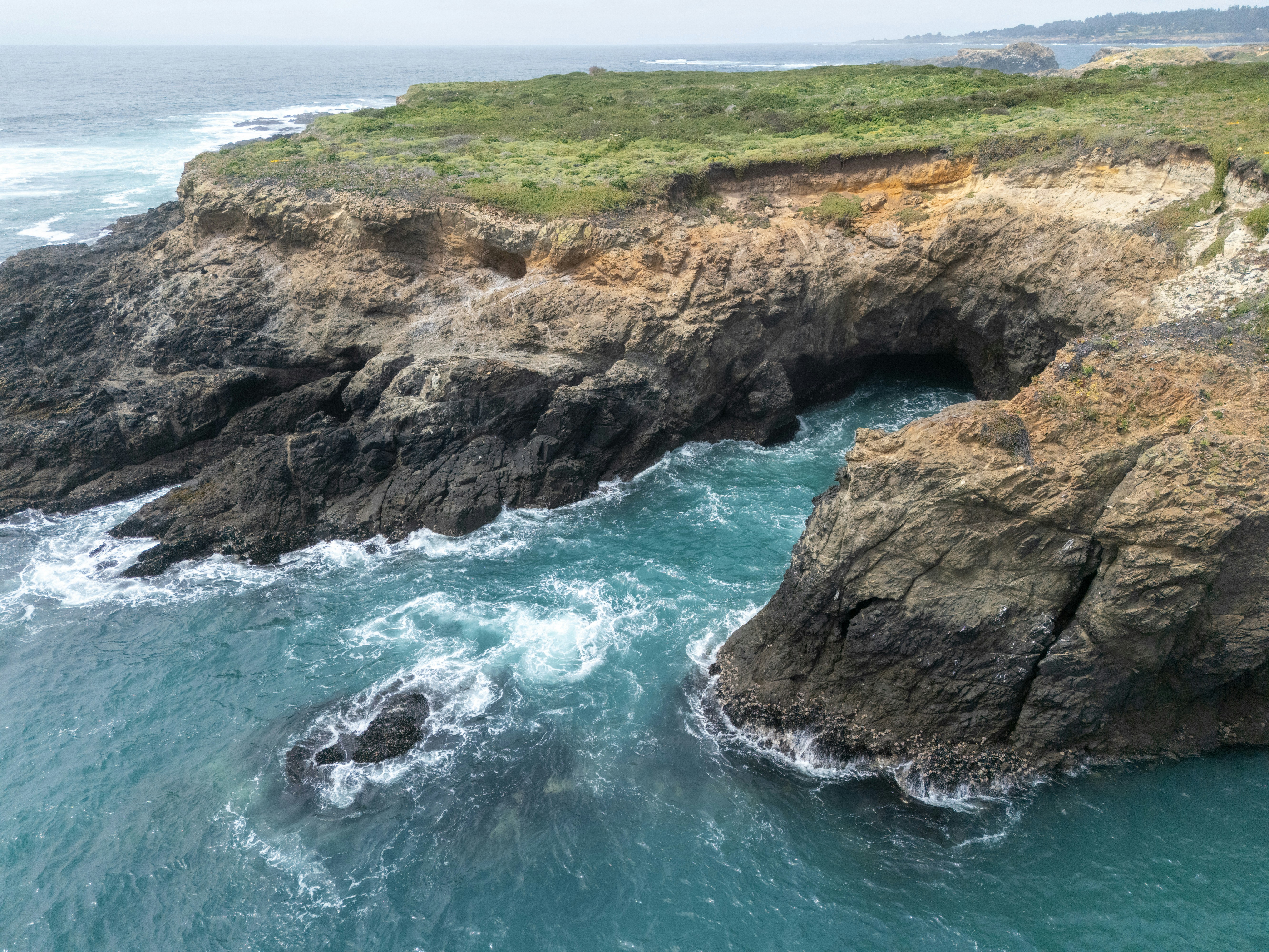 Sea Cliff Arch: Turquoise Waters Weaving Through Stone