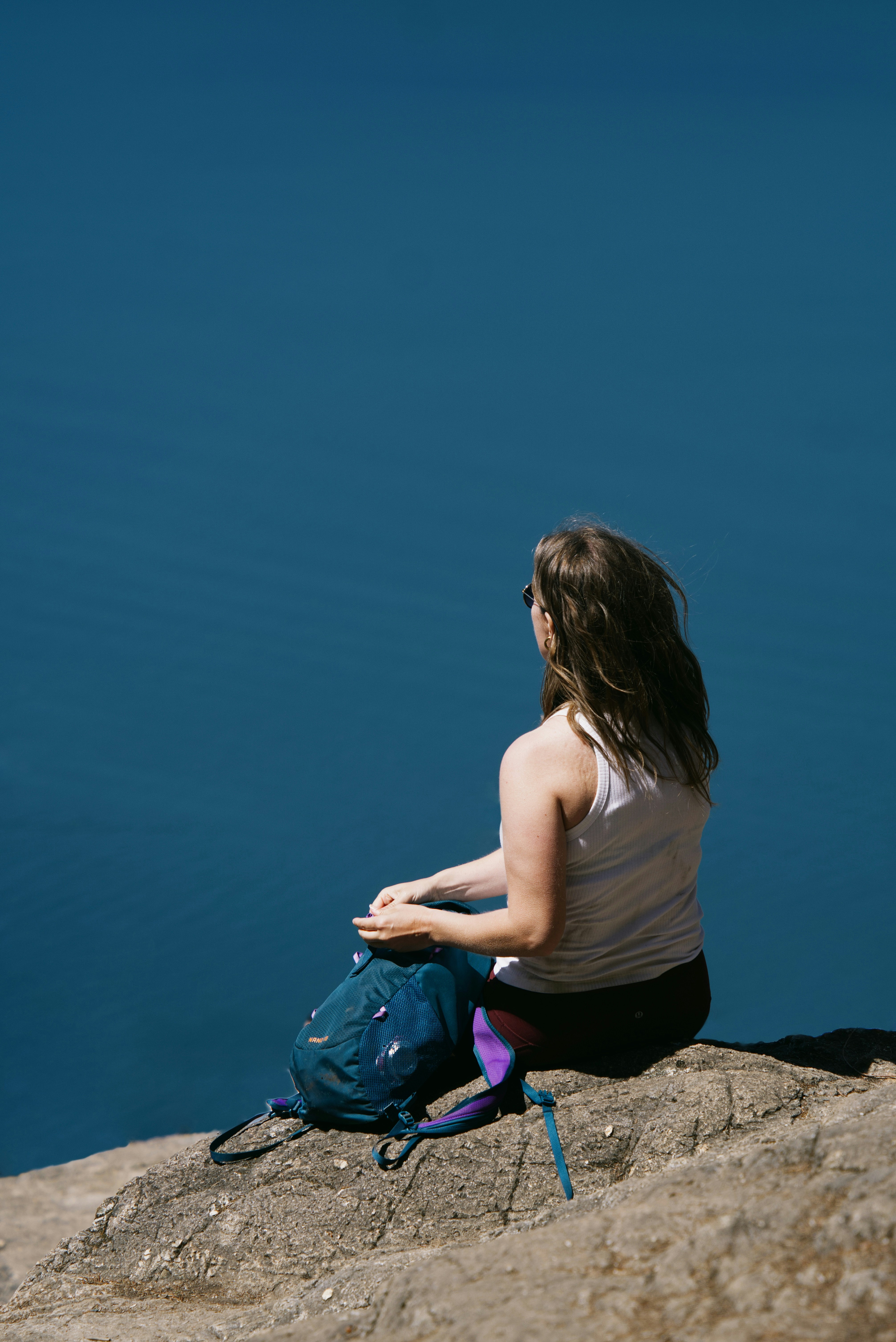 Seated by the Edge: A Quiet Moment on the Cliff