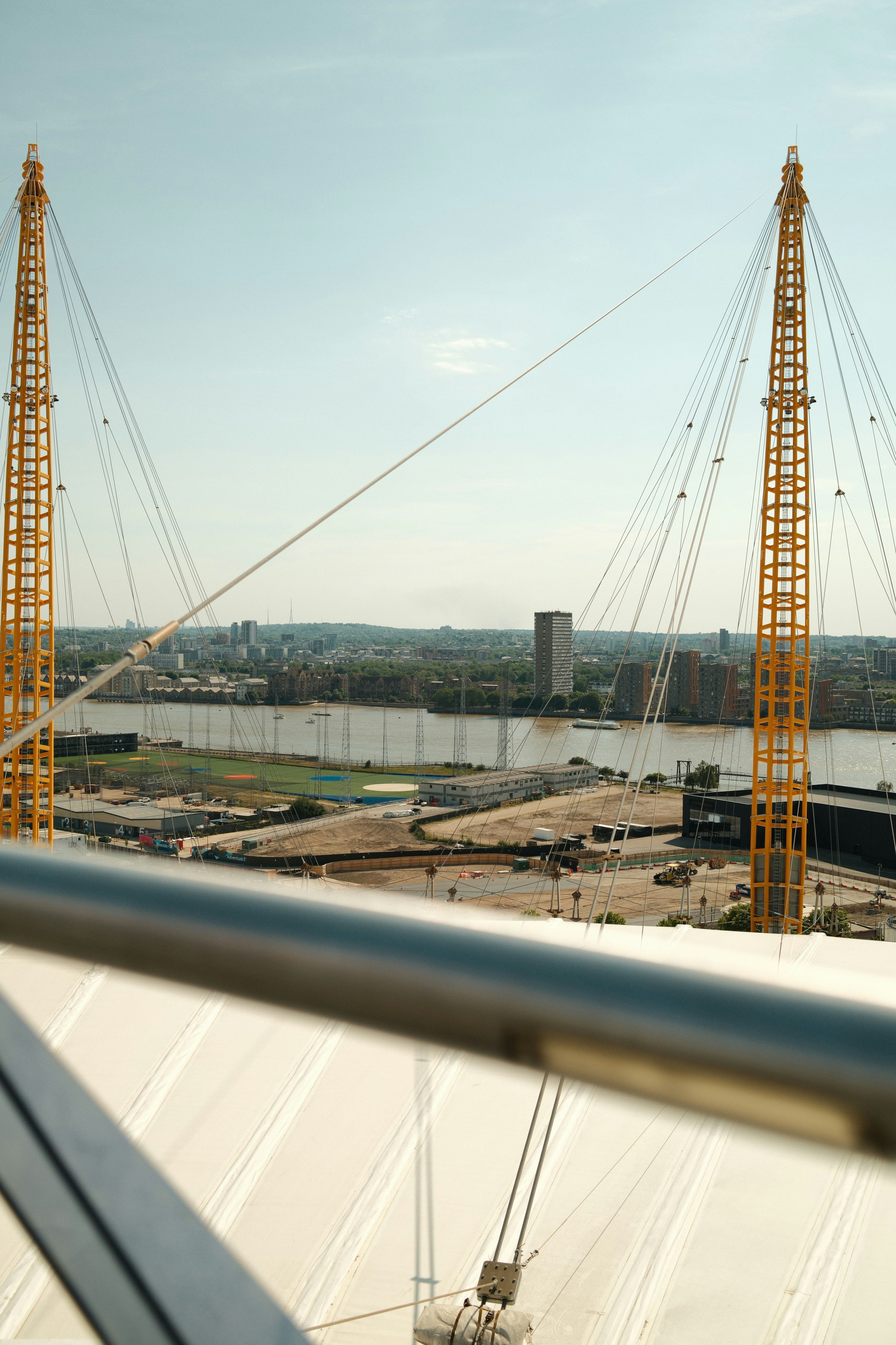 Cable-stayed Bridge Tower Framed Against a Riverside Skyline