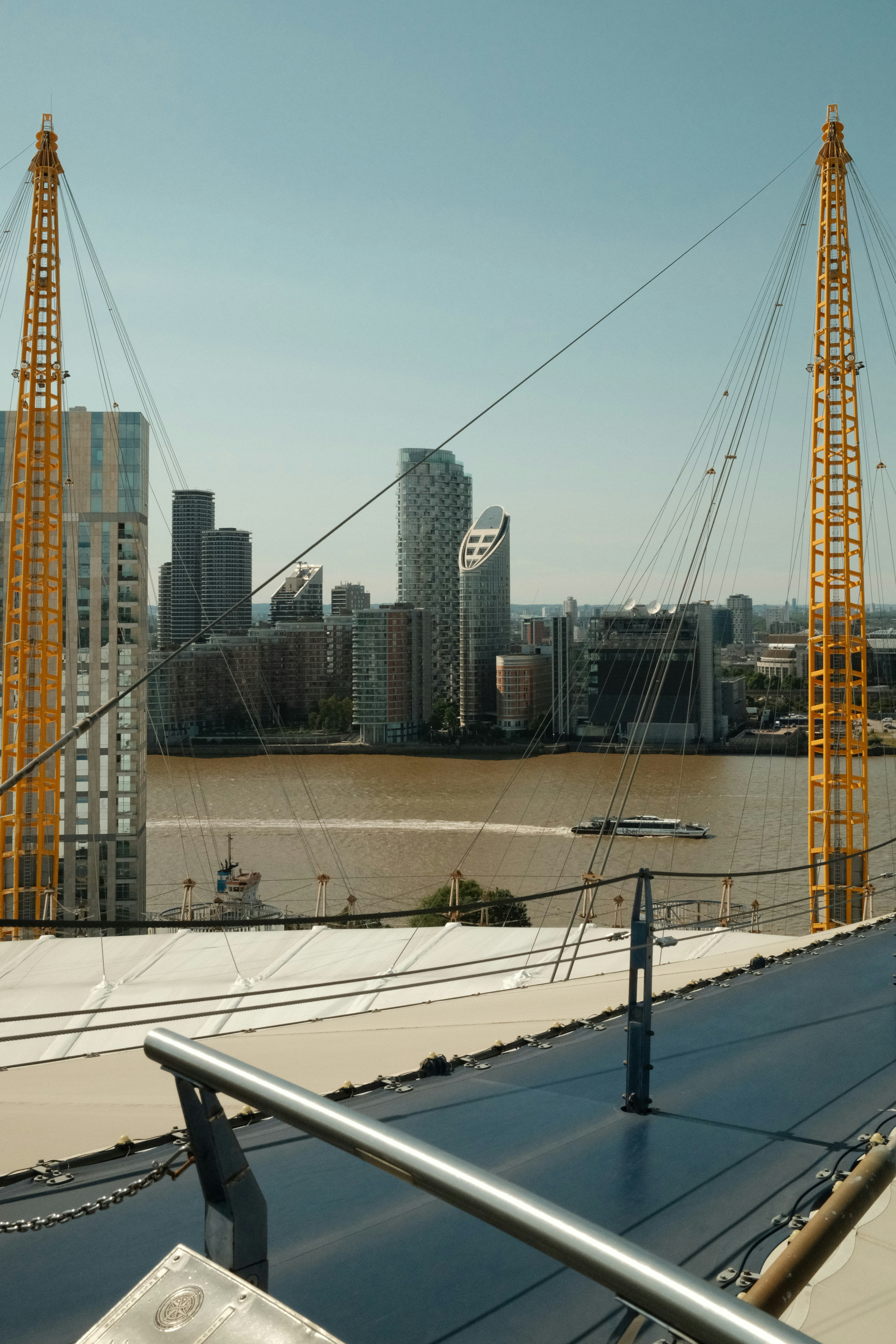 Cityscape over the Thames: Cable-stayed cranes framing a metropolitan skyline