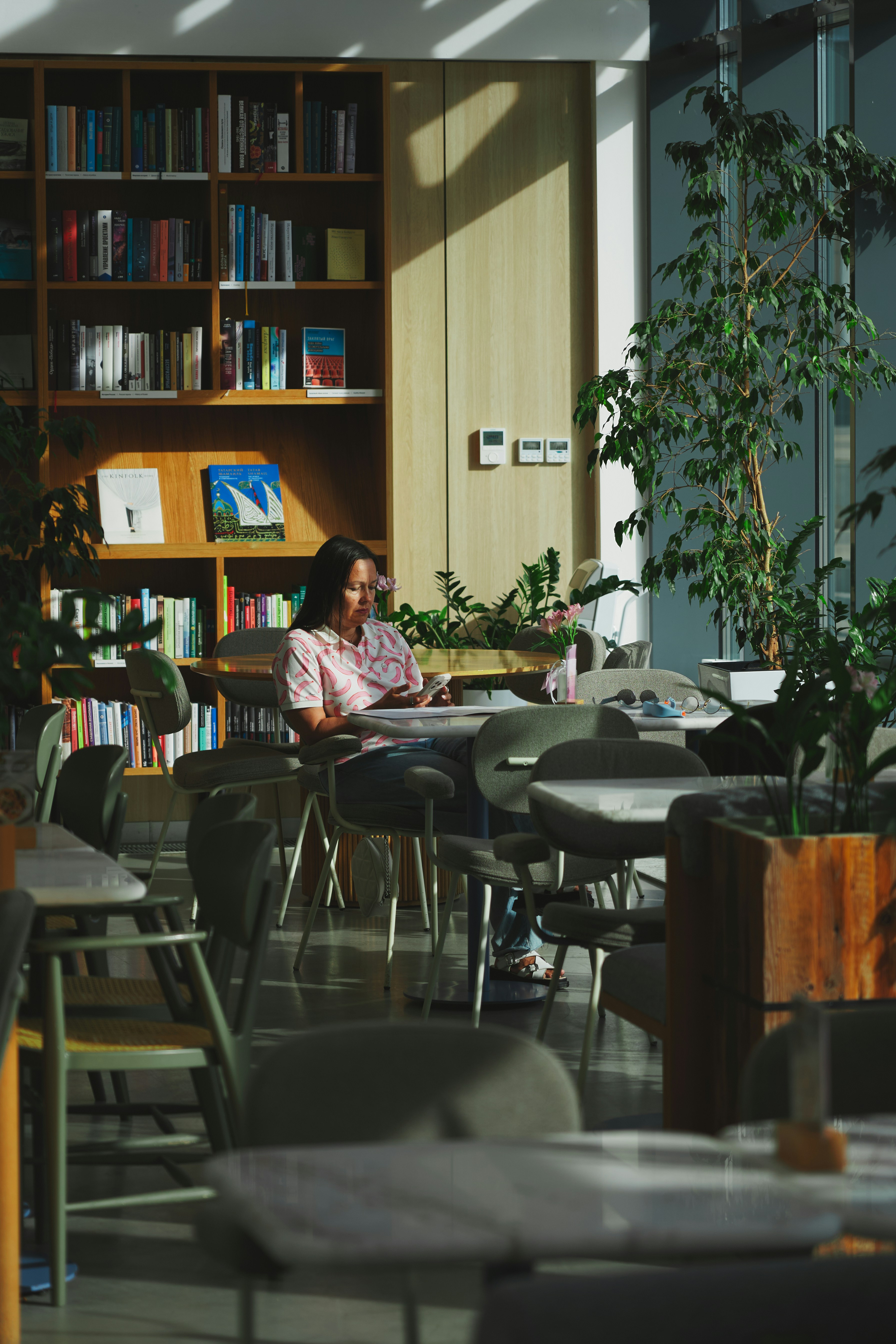 Quiet Reading Moment in a Sunlit Library Café