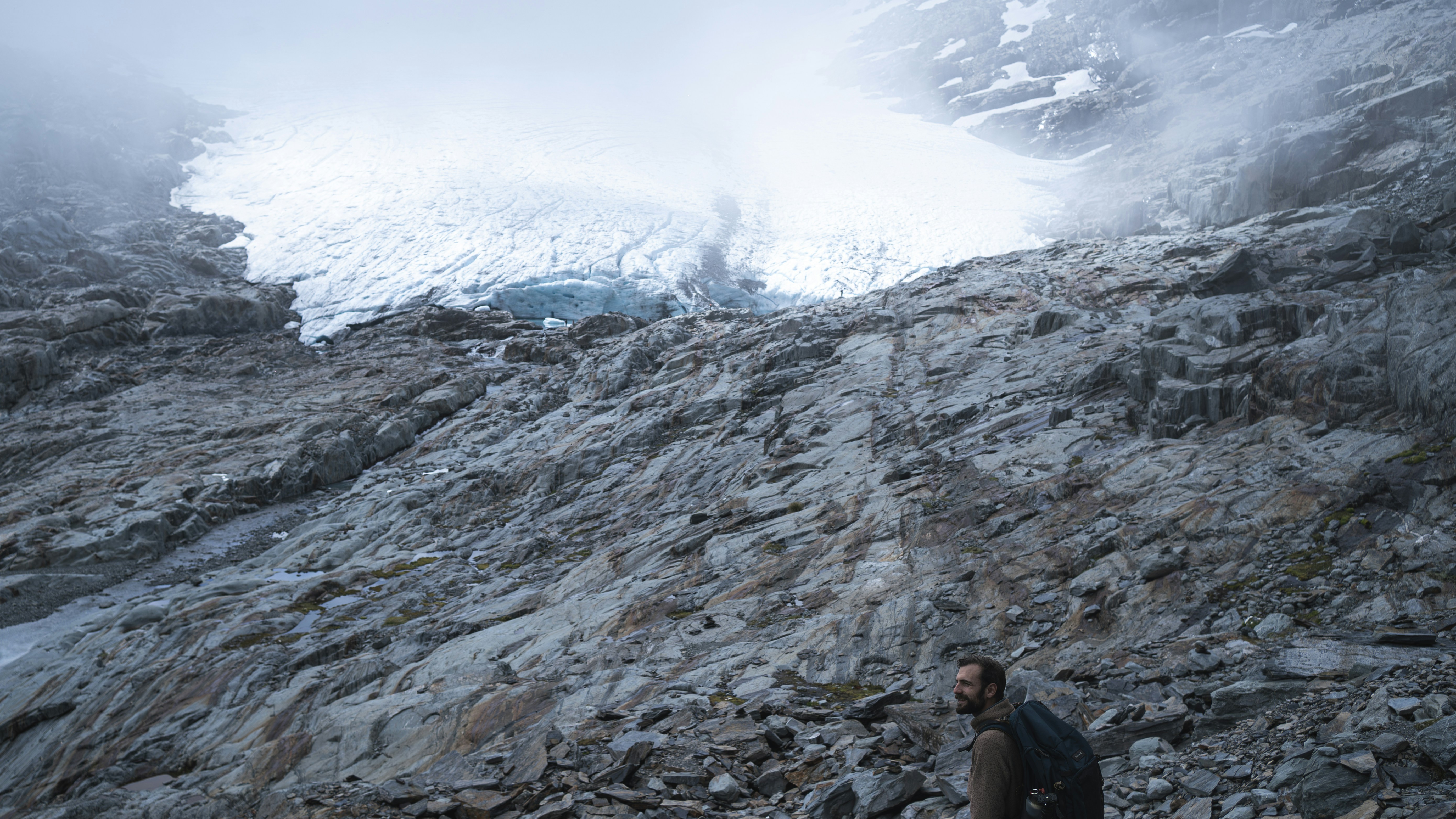 Cliffside Wanderer Beneath Glacial Light
