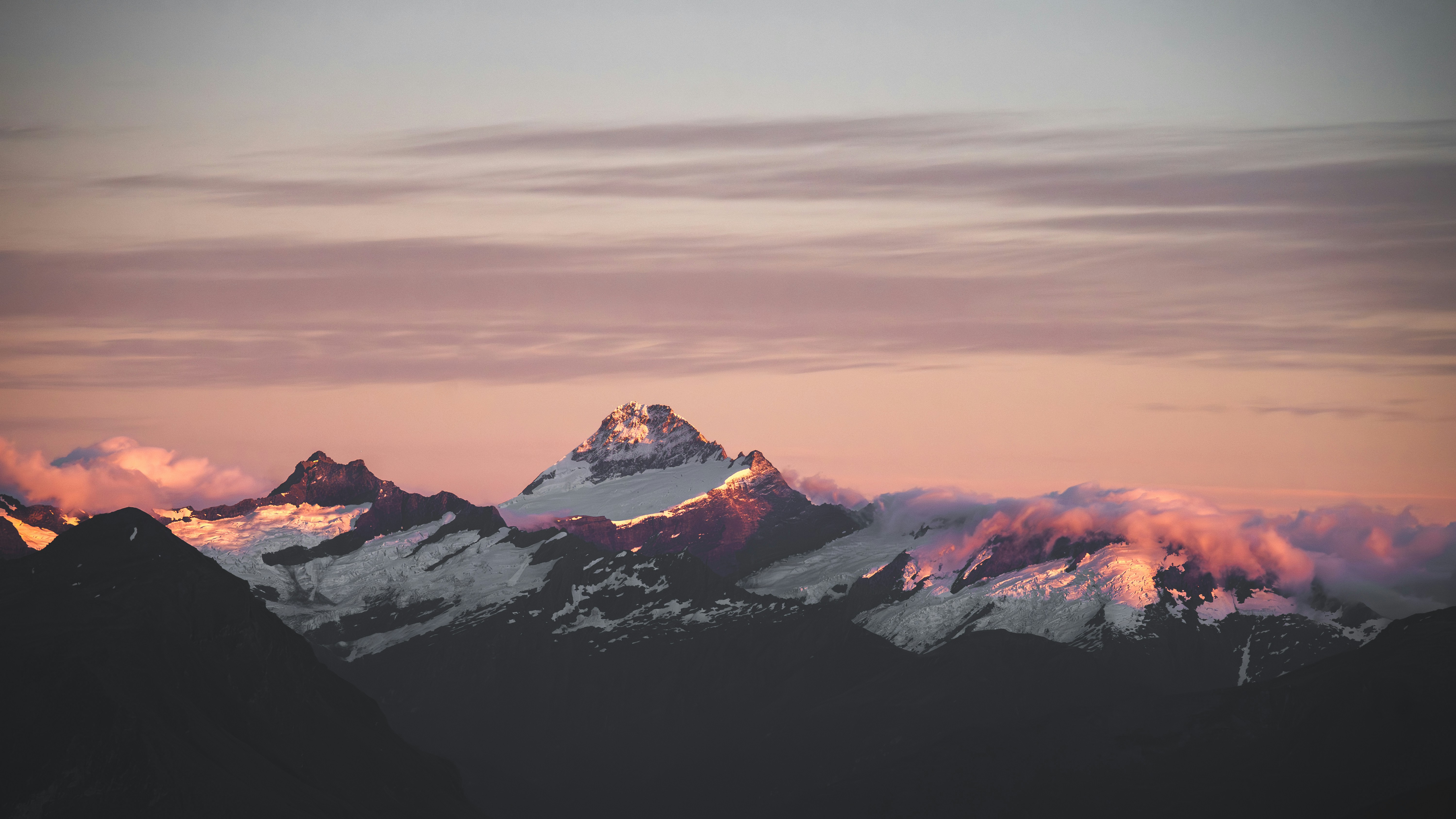 Twilight Crest: A Snowlit Peak Under Coral Skies