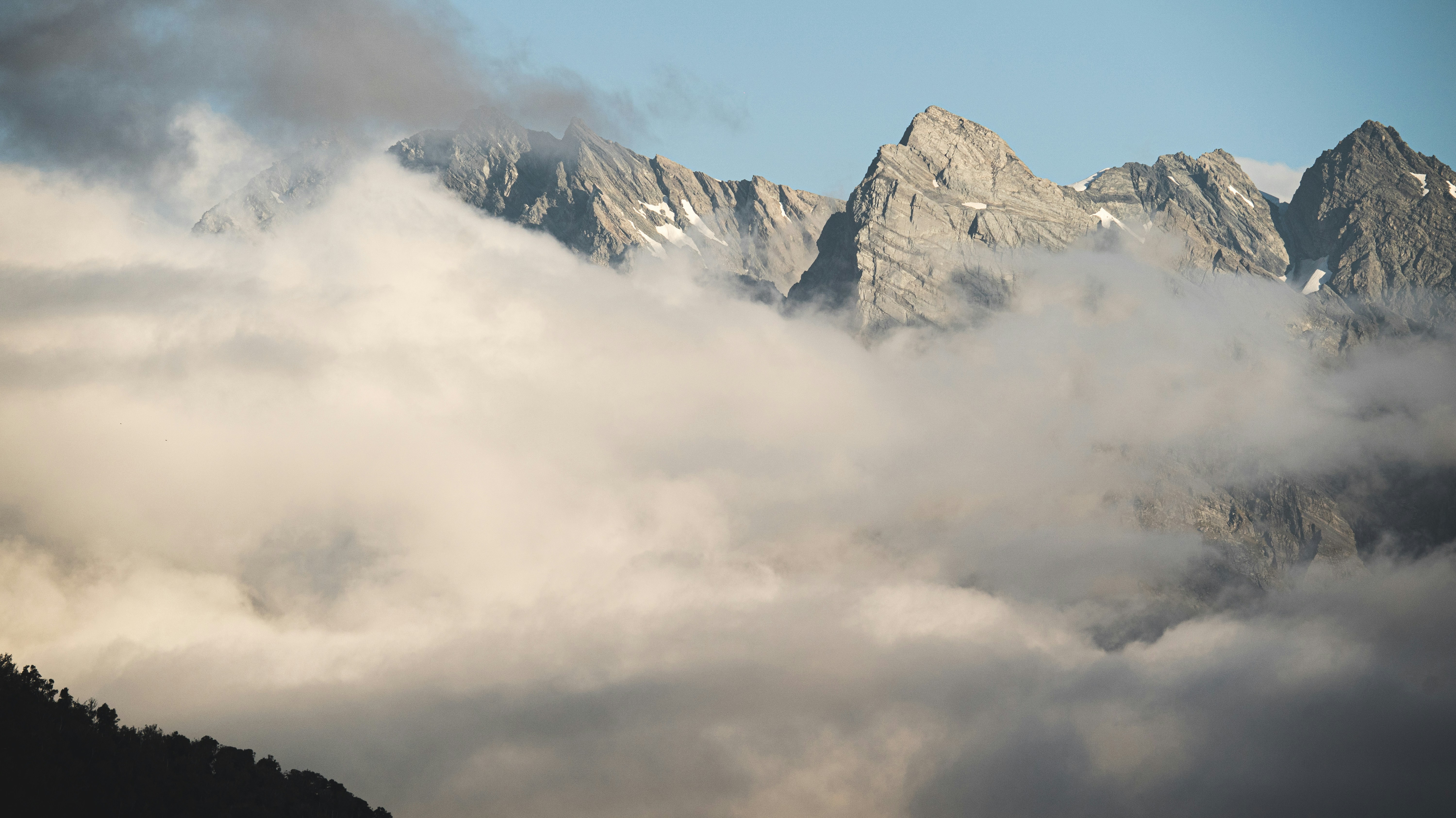 Sunlit Peaks Piercing Through a Sea of Clouds at Dawn