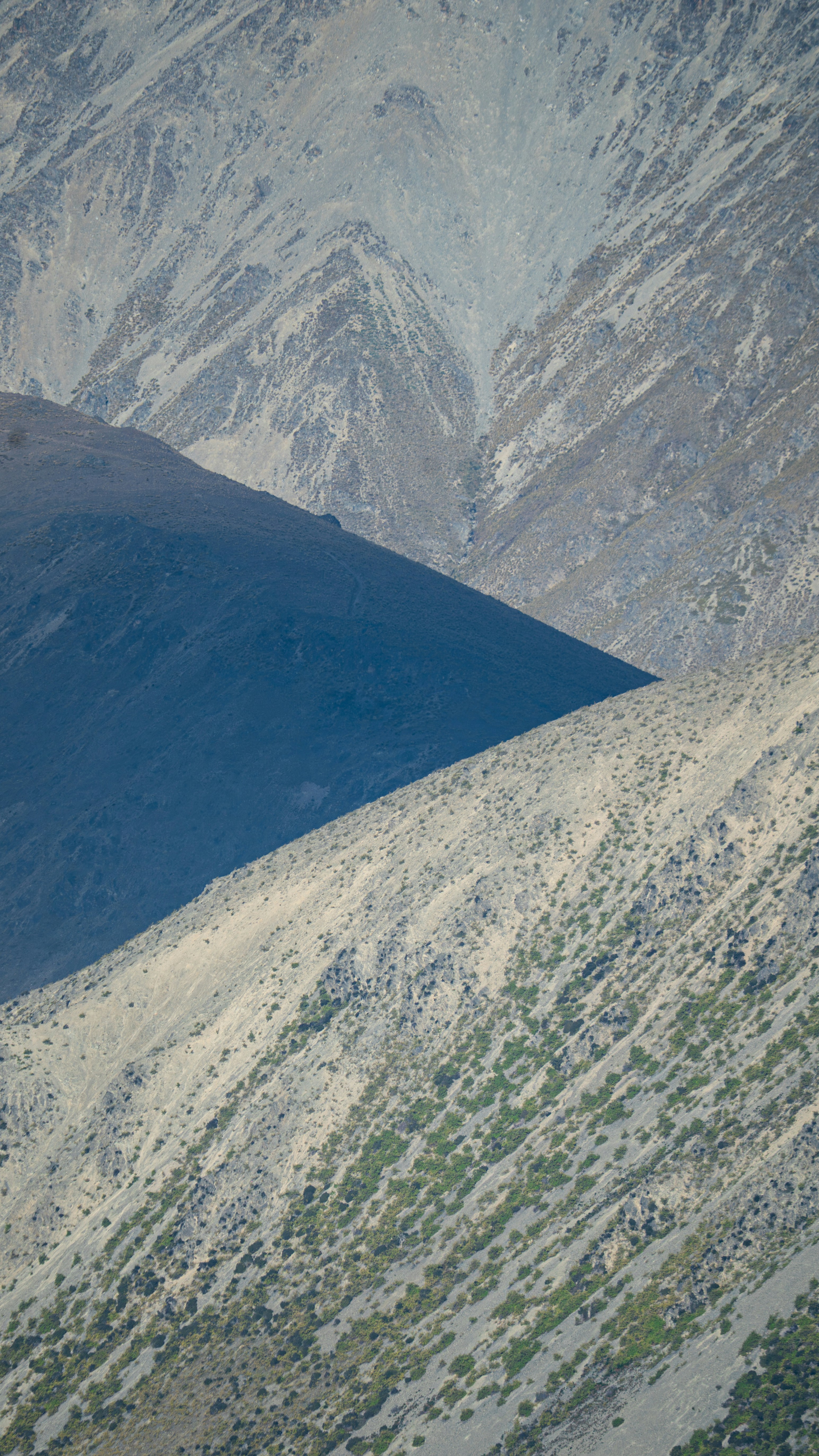 Tilted Ridge Ascent: Blue Shadowed Mountain Face