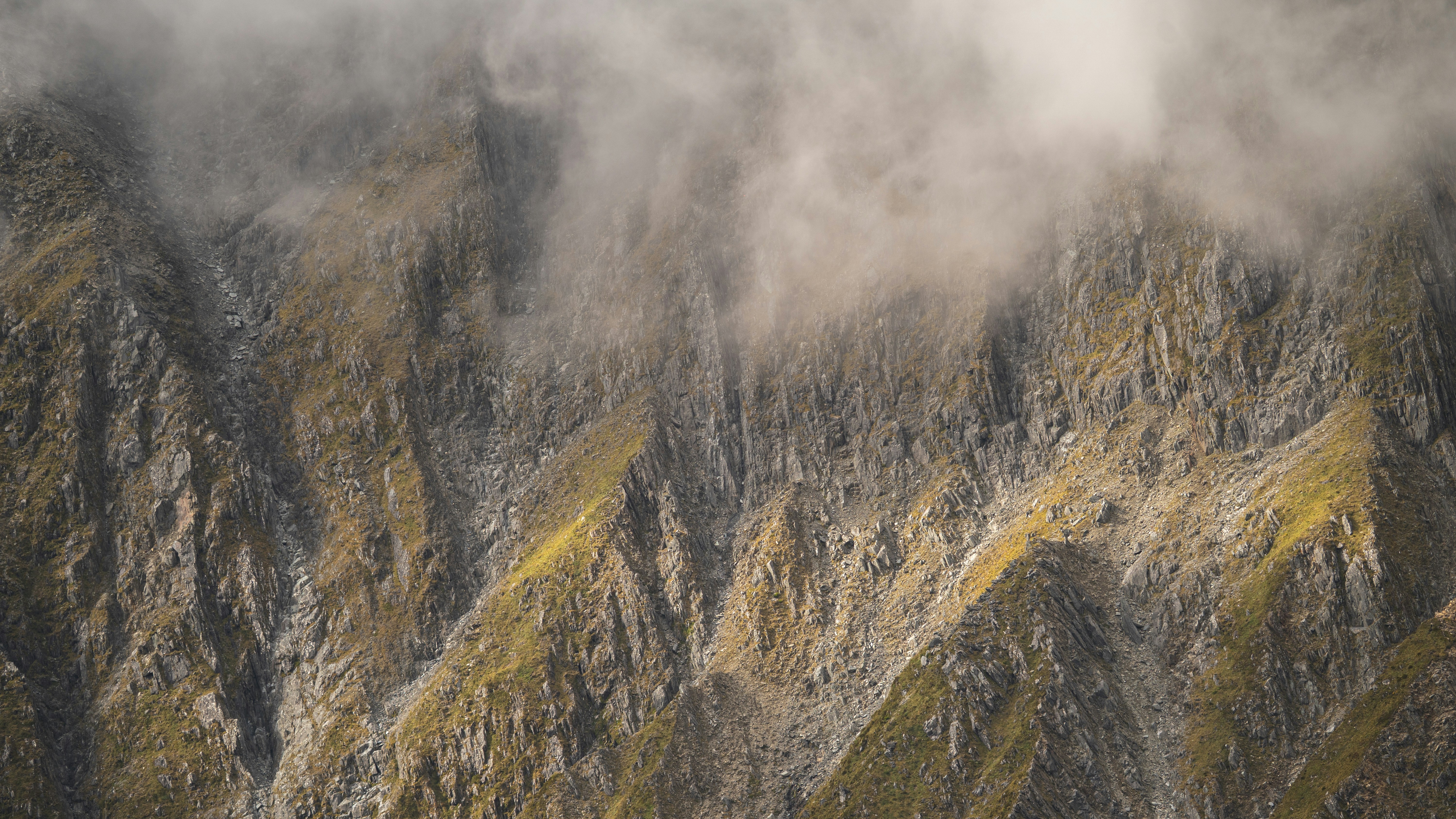 Mist-Laden Crags: A Clash of Light and Stone