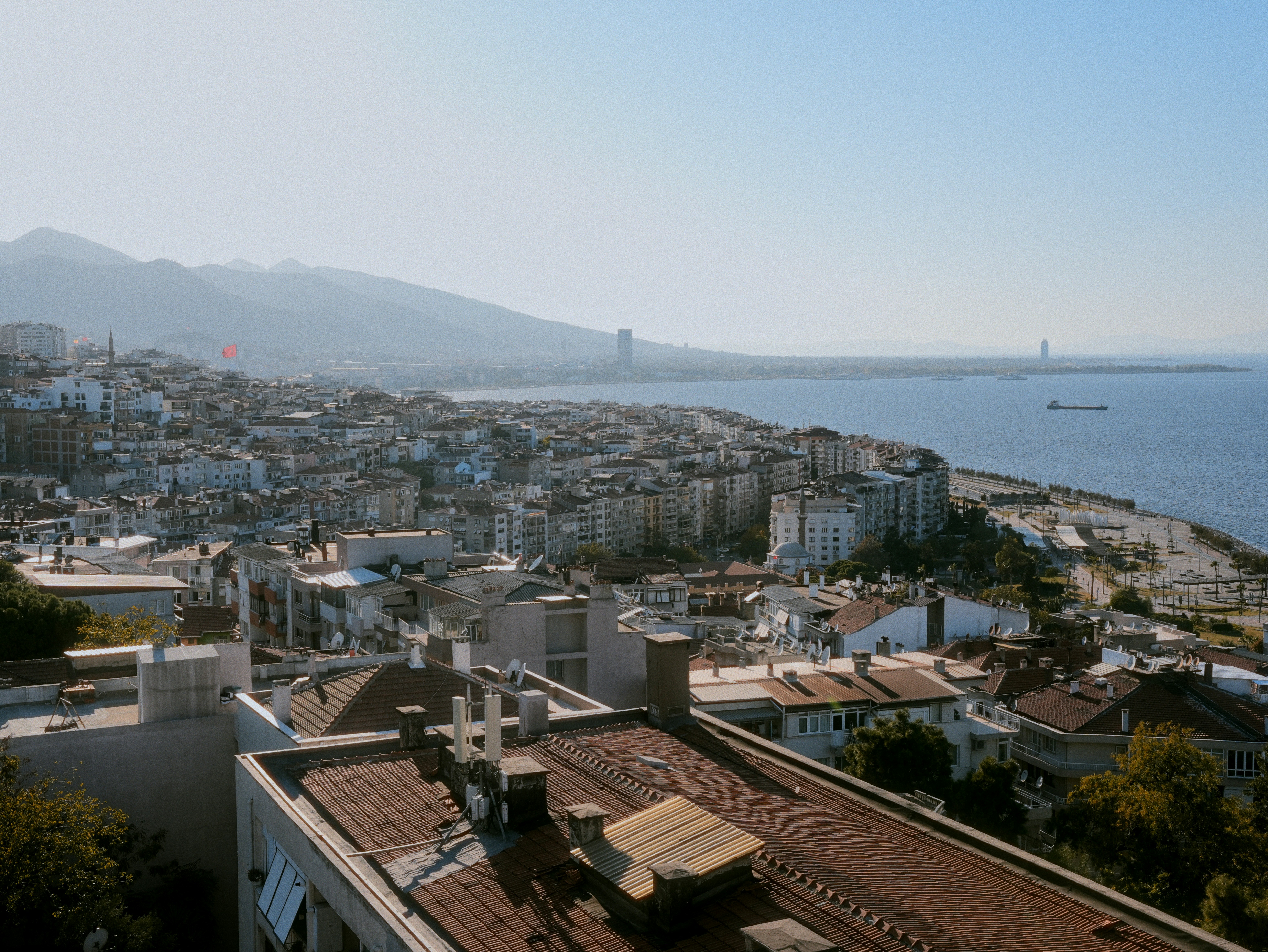 Coastal Cityscape: A Sunlit Rooftop Cascade Over Looking the Bay