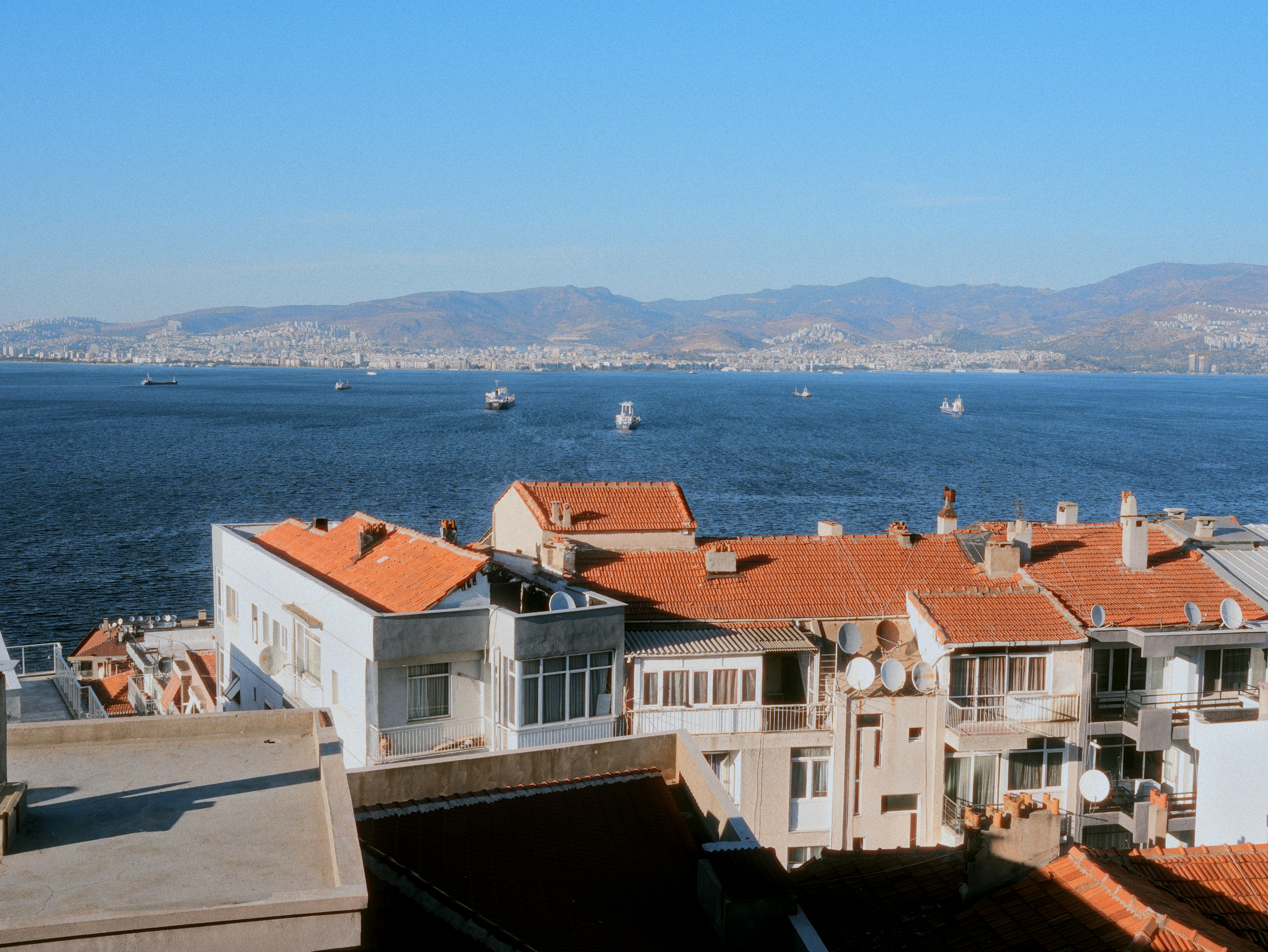 Terracotta Rooftops Overlooking a Sea of Distant Mountains