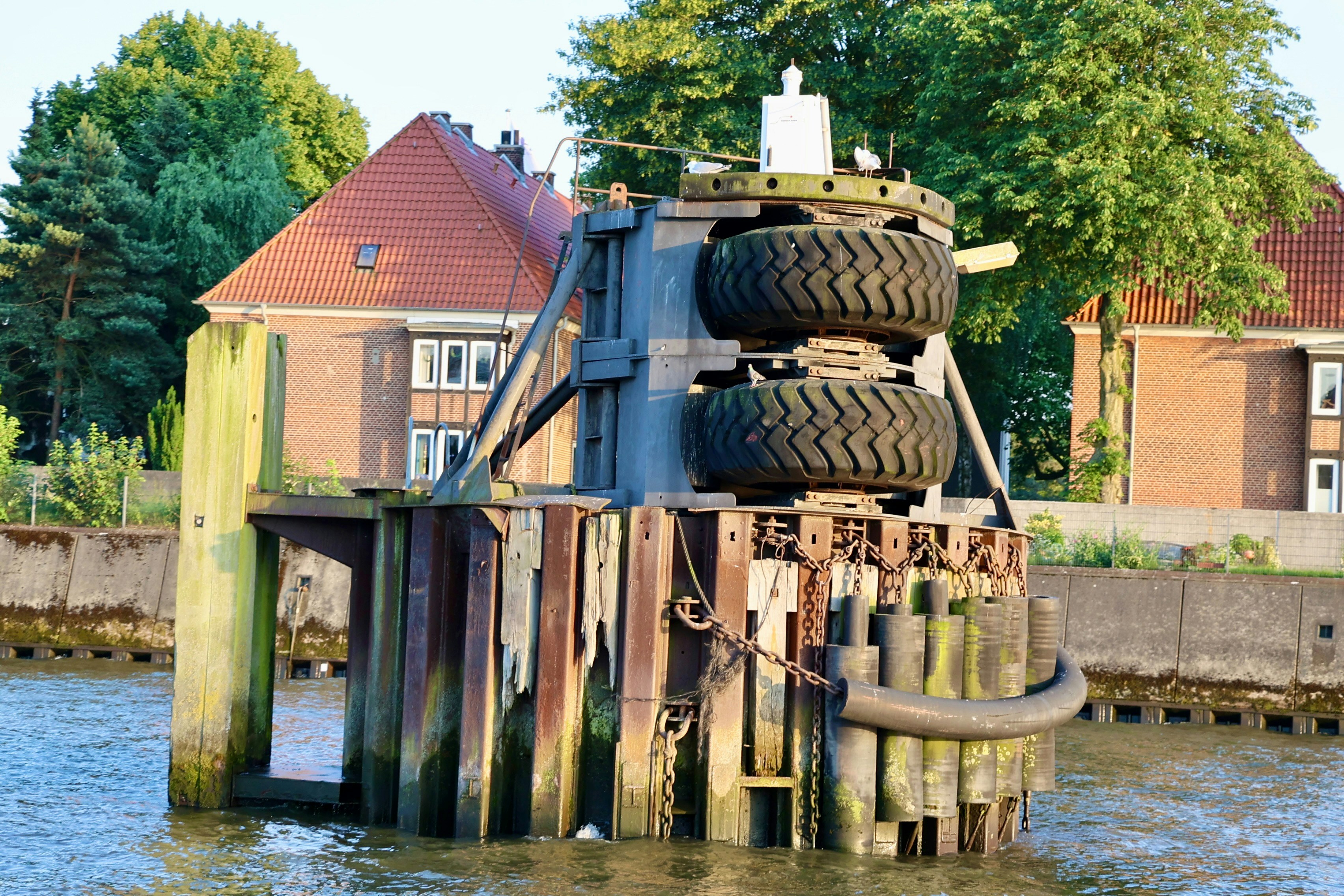 A Weathered Ferry Landing: Wheels and Water in a Quiet Riverside