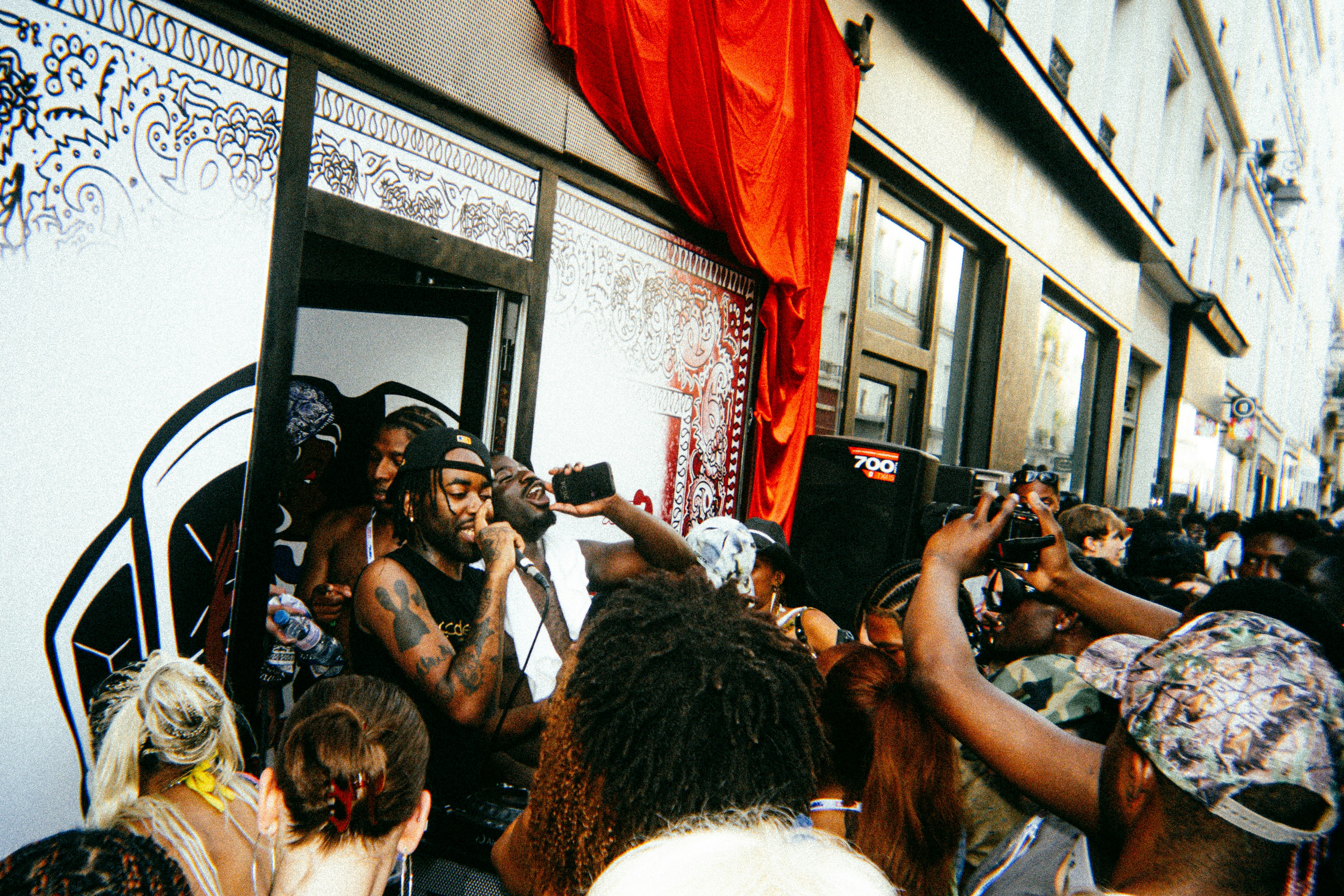 Red Cloth, Loud Crowd: A Street-Melody Moment