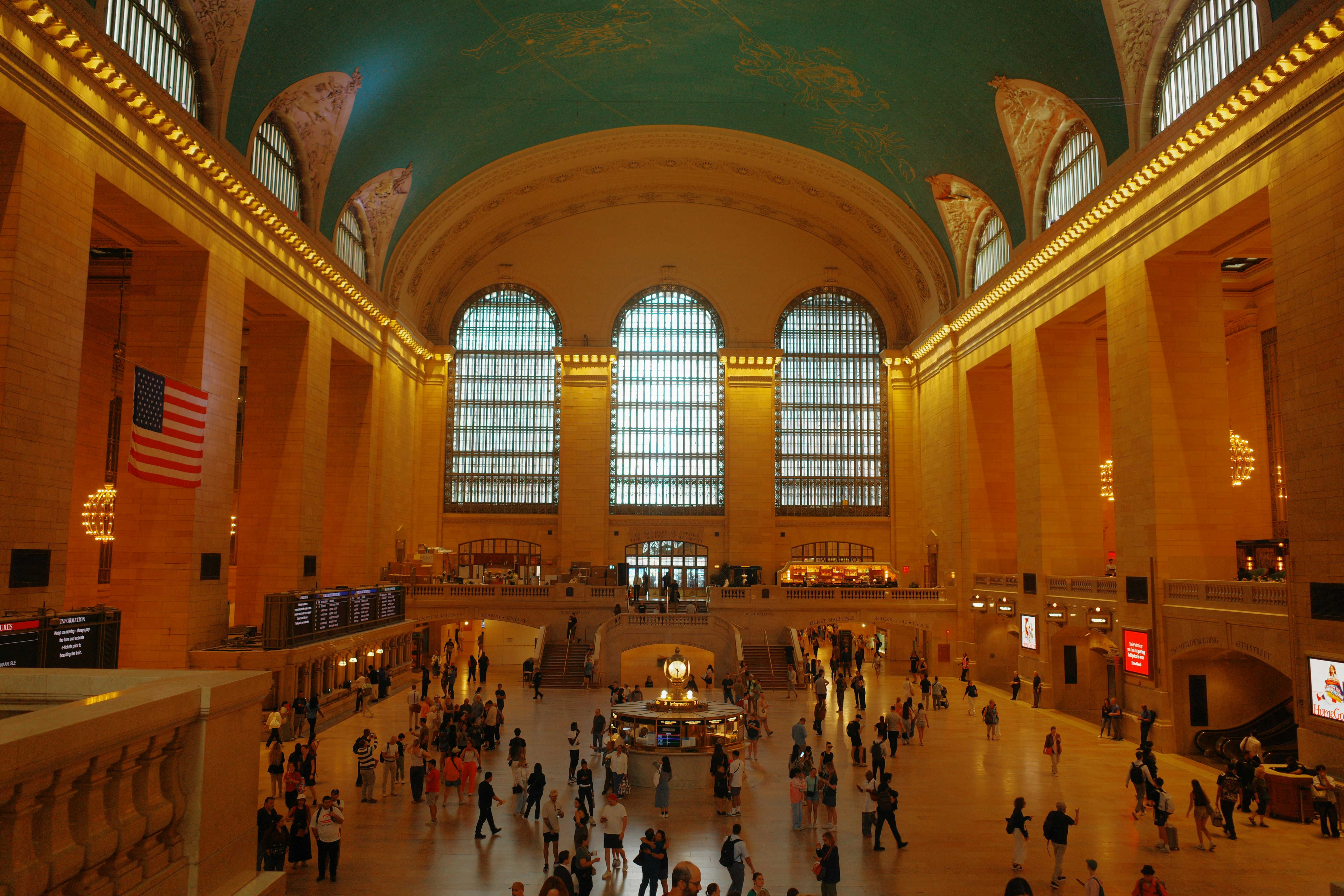 Atop the Grand Hall: People Hover Like Ashes in Sunset Light