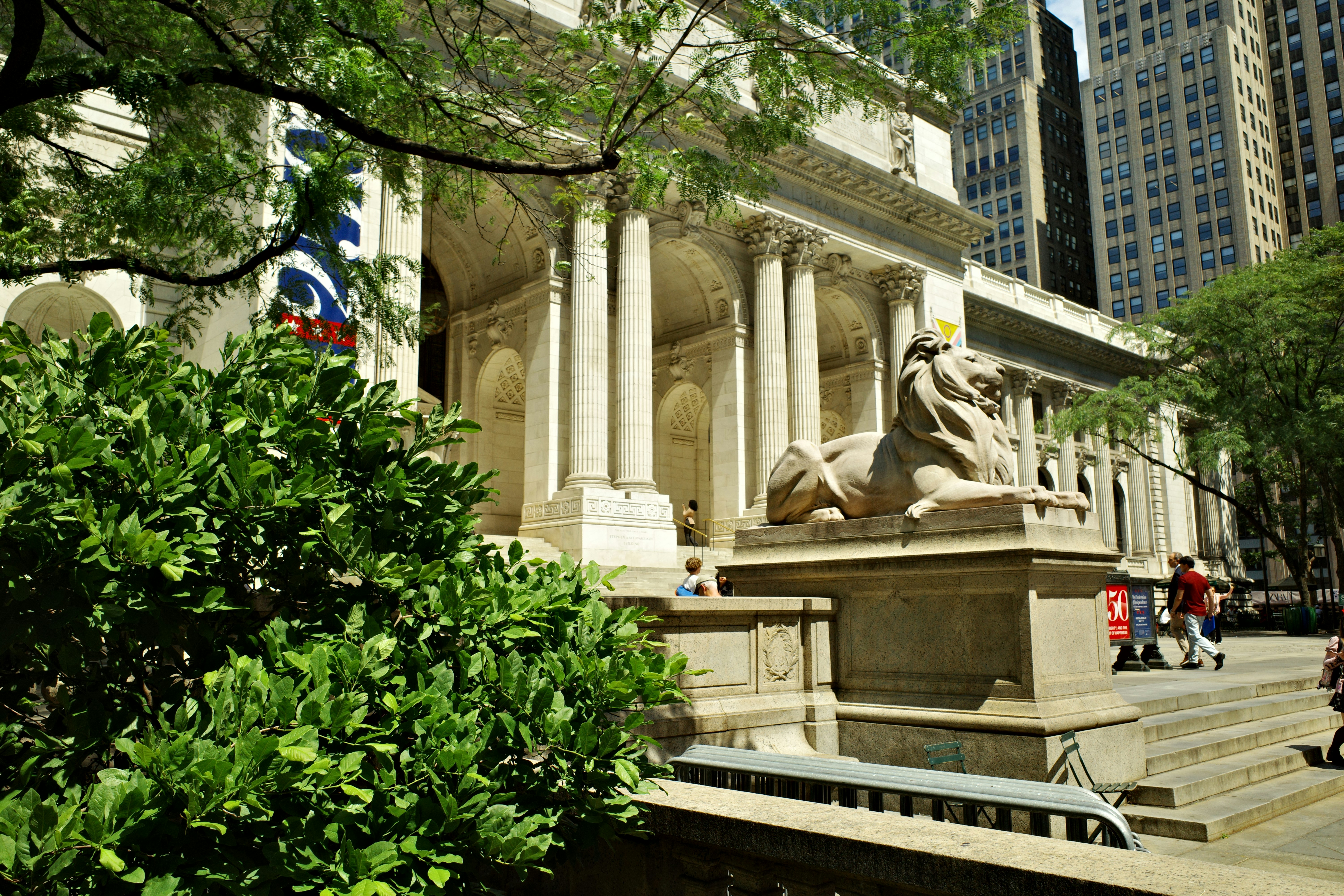 Statue and Neoclassical Steps Framed by Urban Greenery