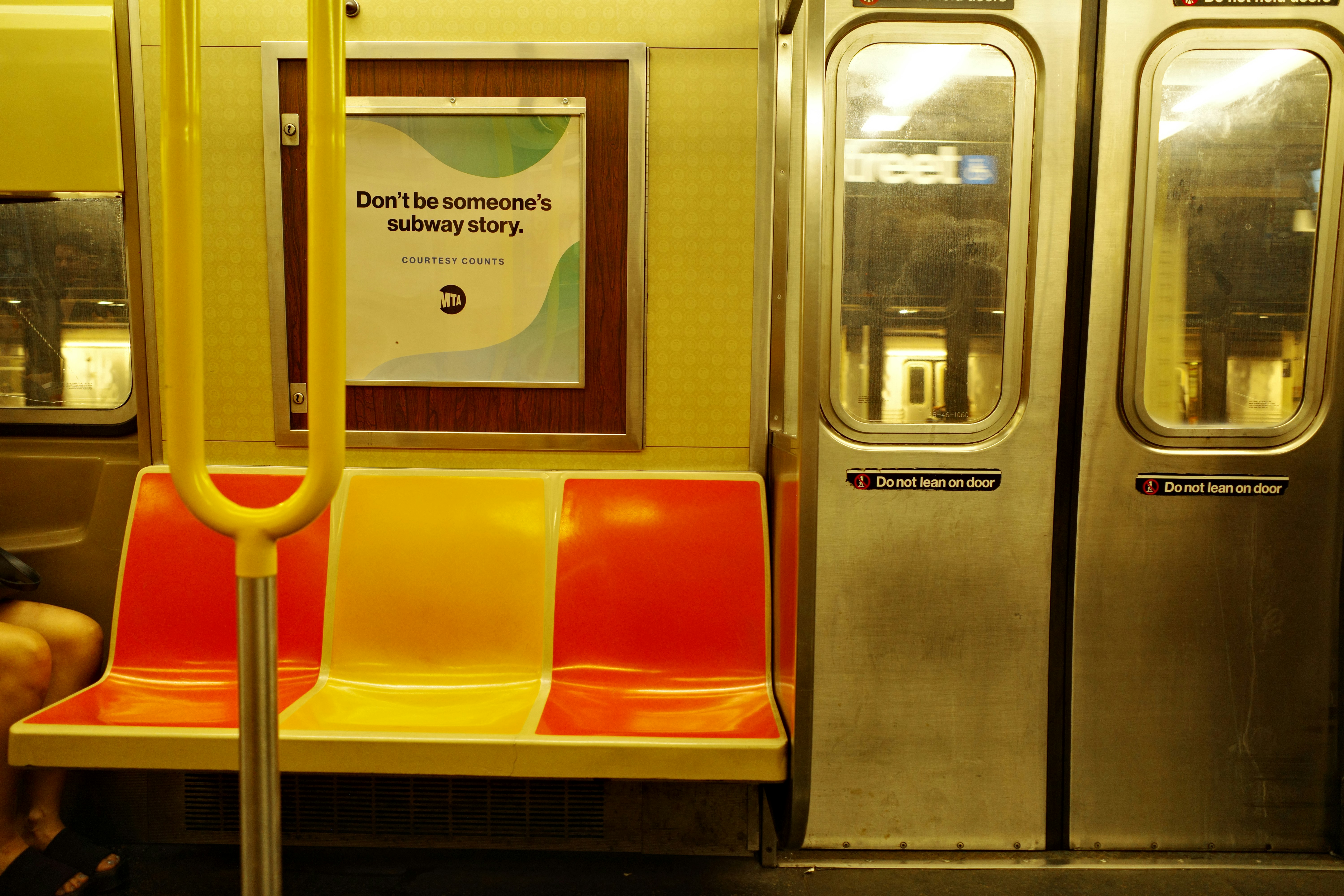 Muted Subway Scene with Painted Seats and Sliding Doors
